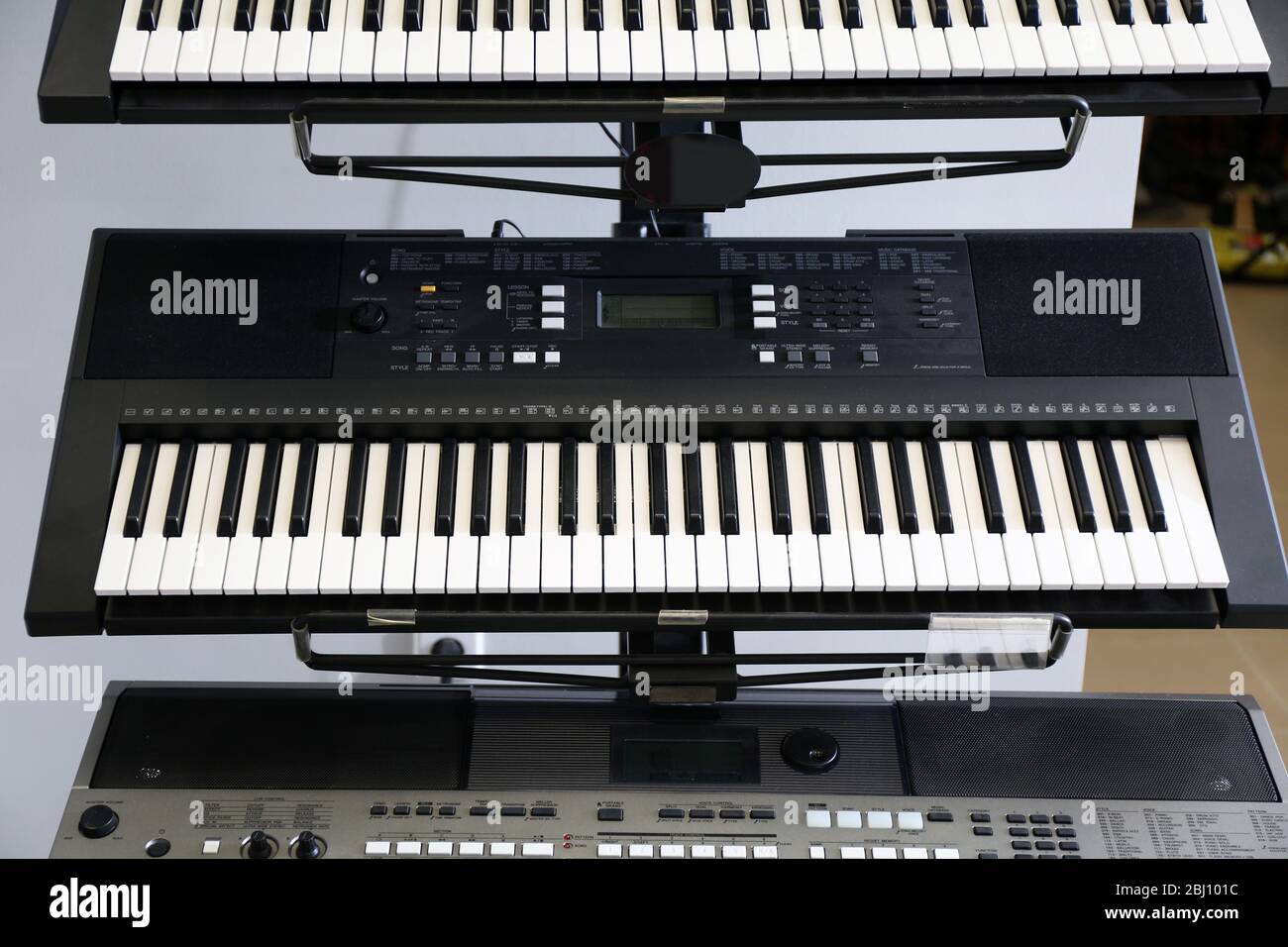 Synthesizers on stand in shop Stock Photo - Alamy