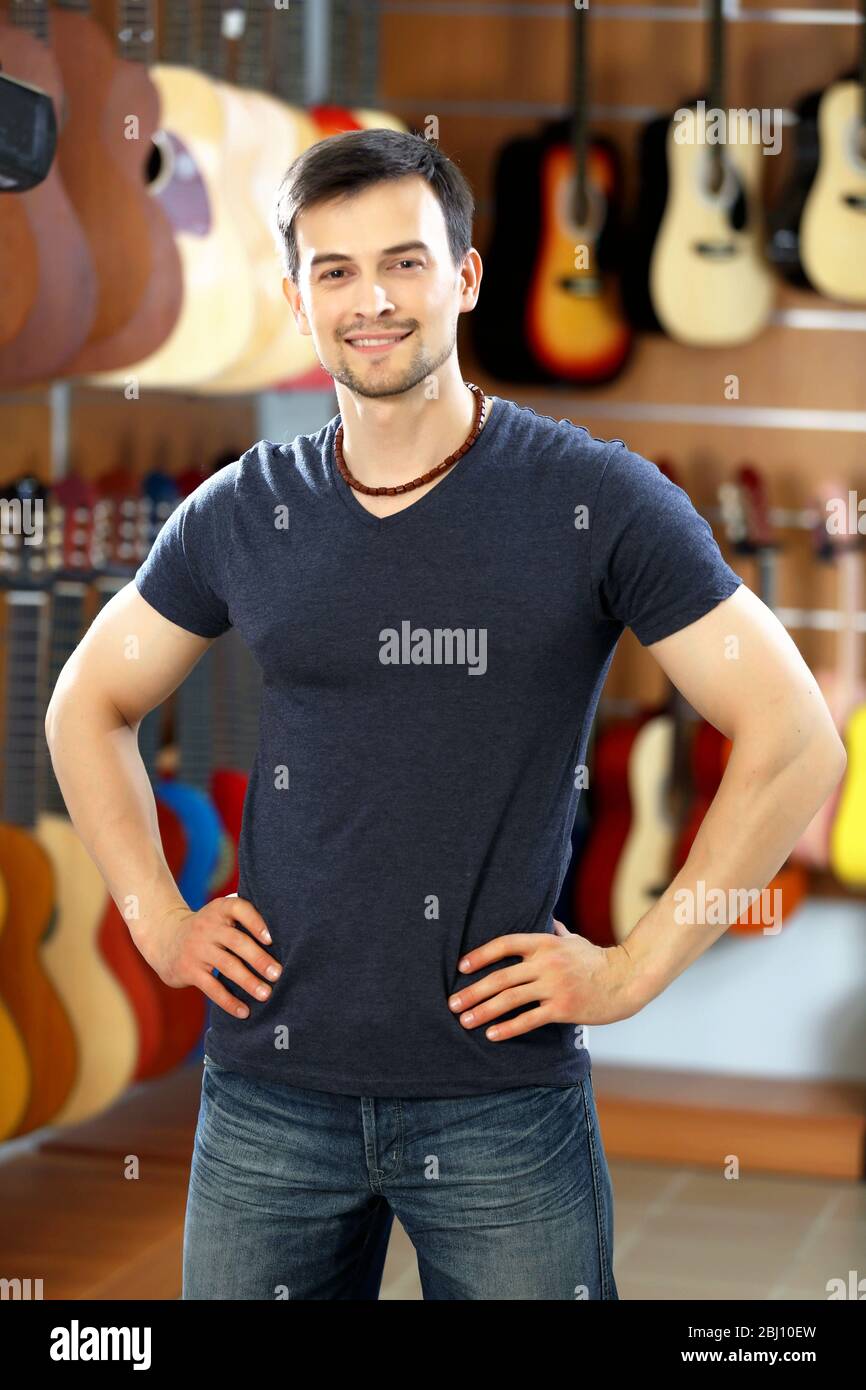 Handsome young man in music store Stock Photo - Alamy