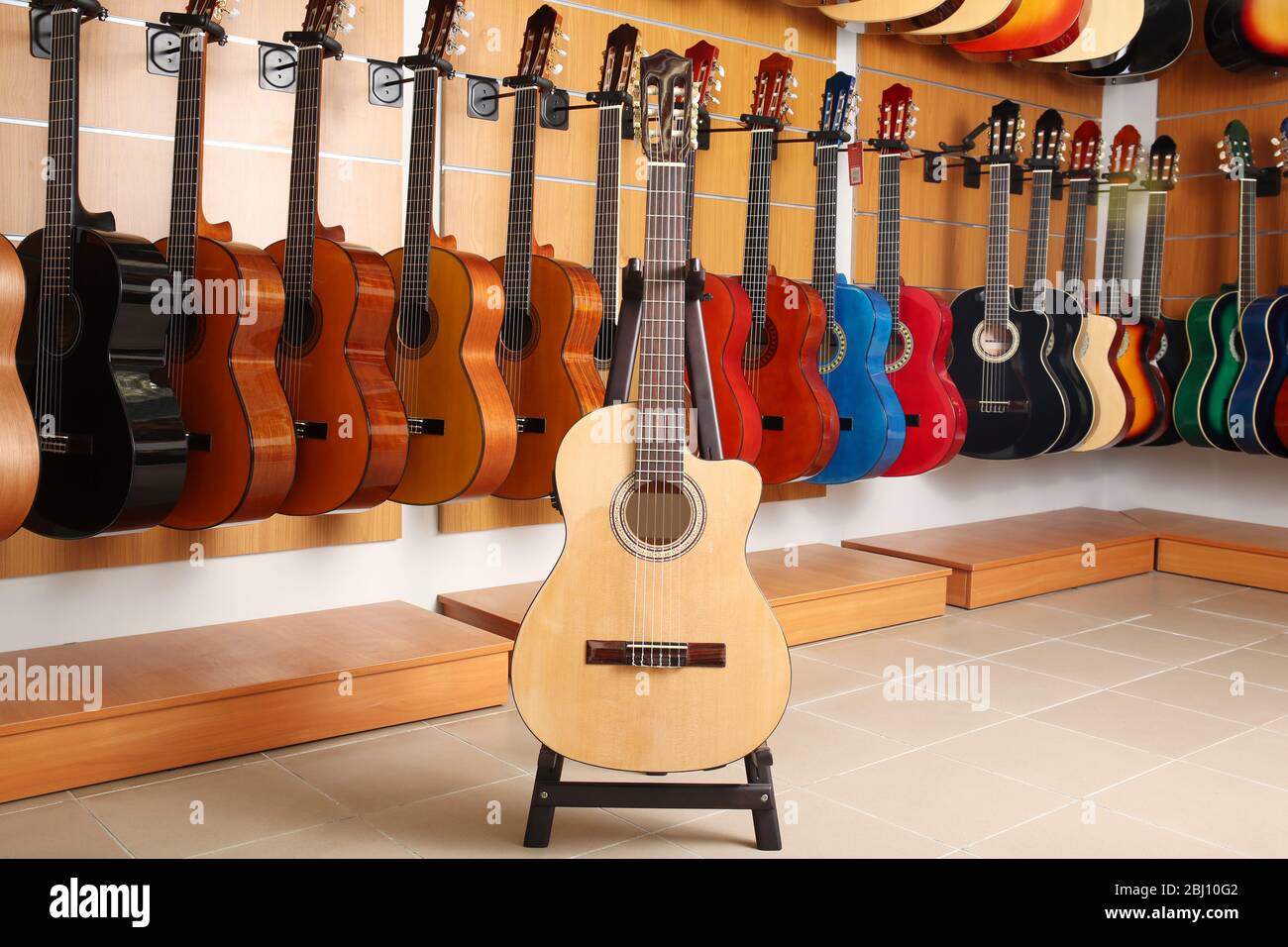 Guitars in music store Stock Photo - Alamy