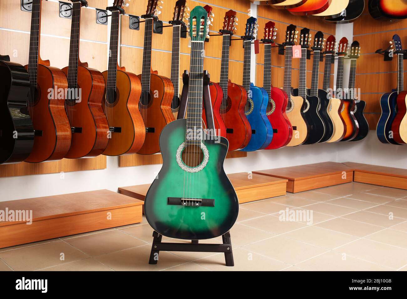 Guitars in music store Stock Photo - Alamy