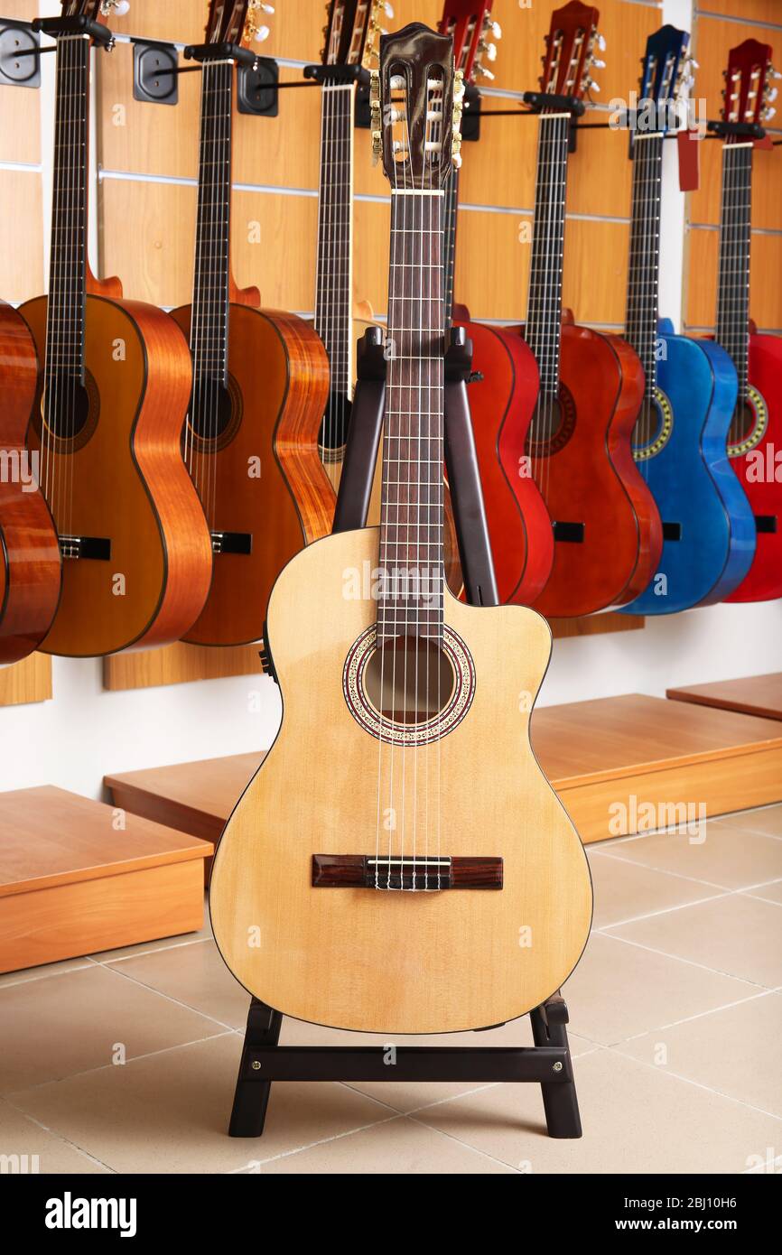 Guitars in music store Stock Photo - Alamy