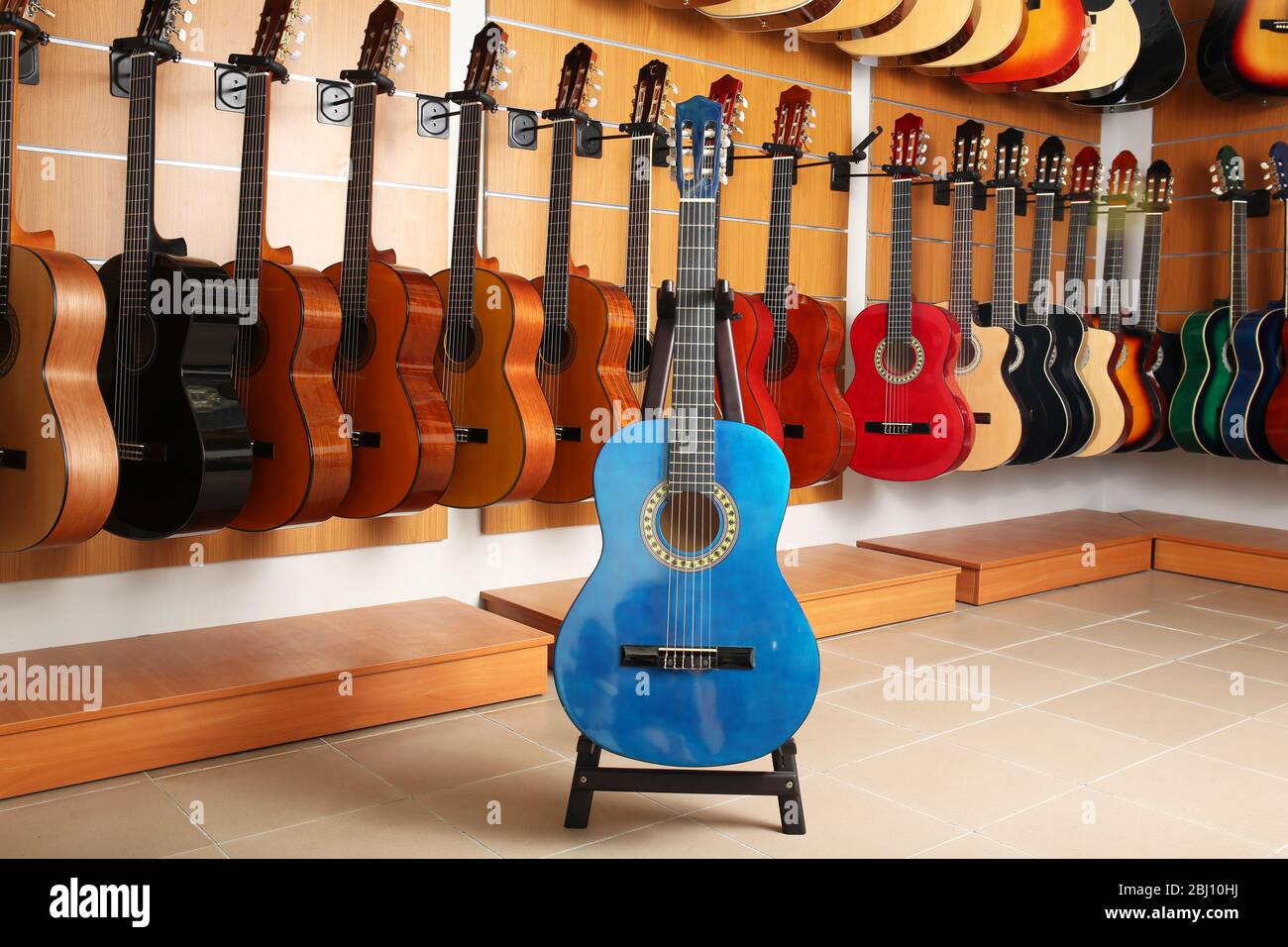Guitars in music store Stock Photo - Alamy