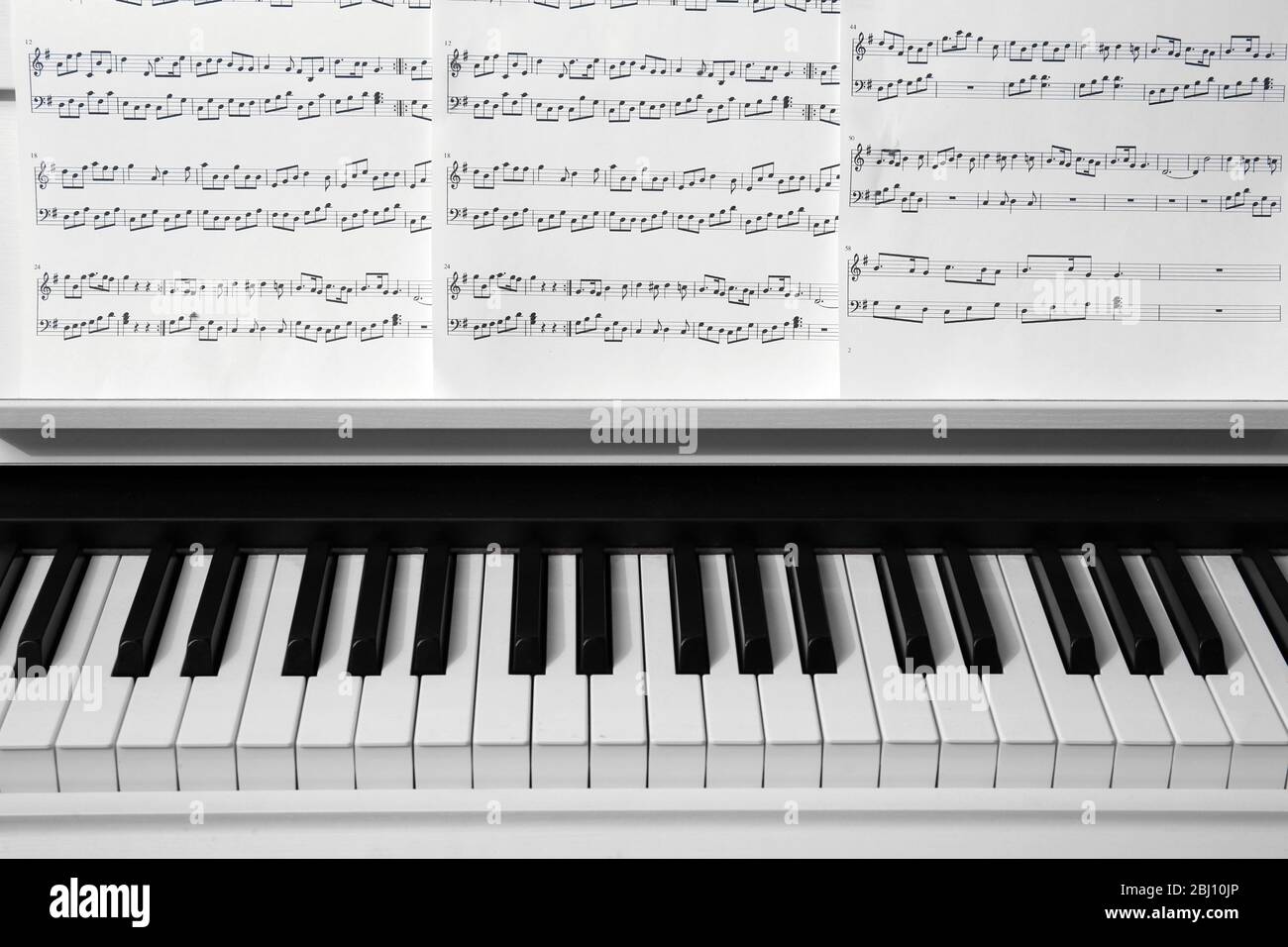Piano with music notes close up Stock Photo - Alamy
