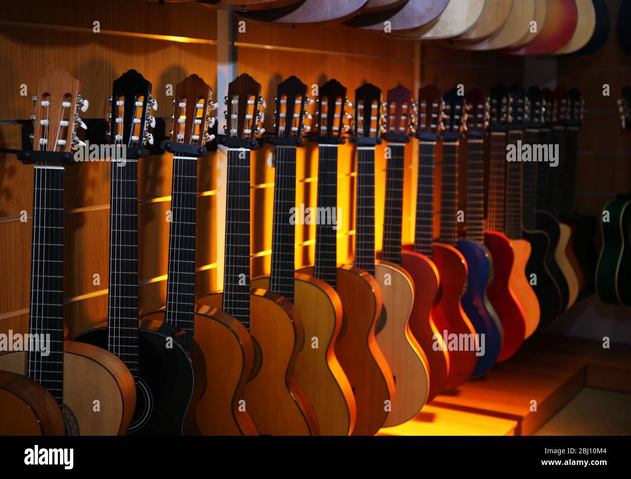 Guitars in music store Stock Photo - Alamy