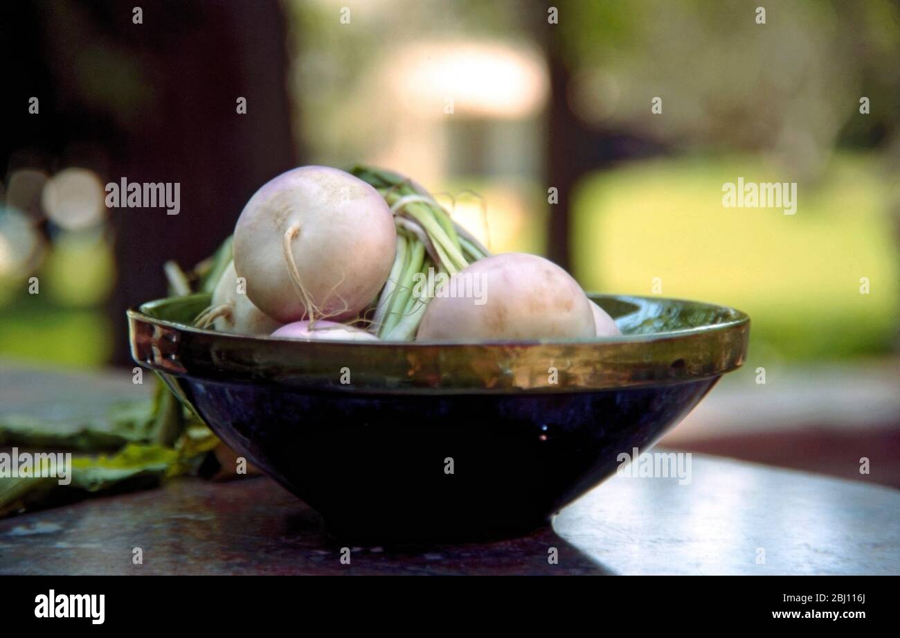 Bunch of baby turnips in green straining bowl Stock Photo - Alamy