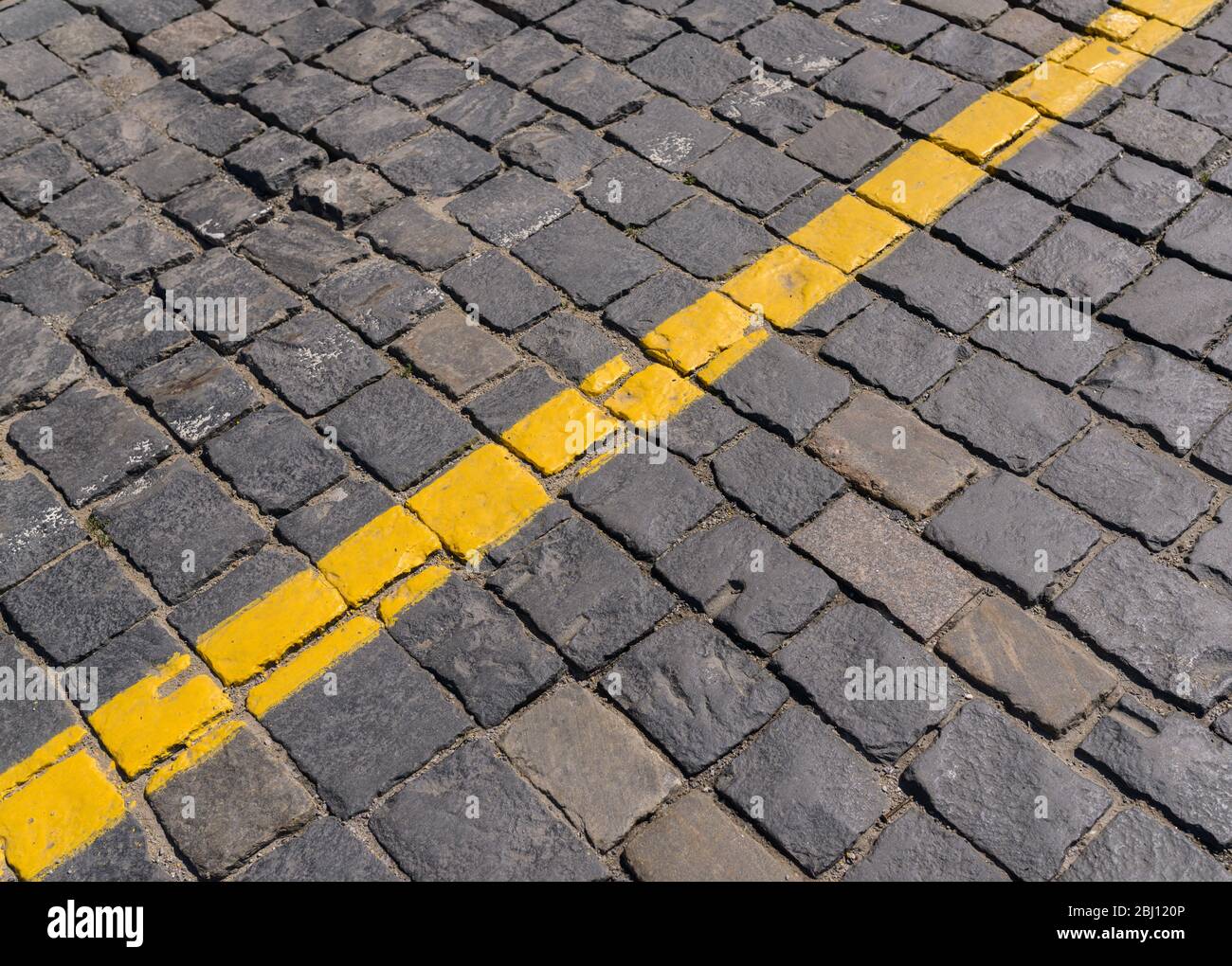 Pavement with a yellow dividing strip Stock Photo - Alamy