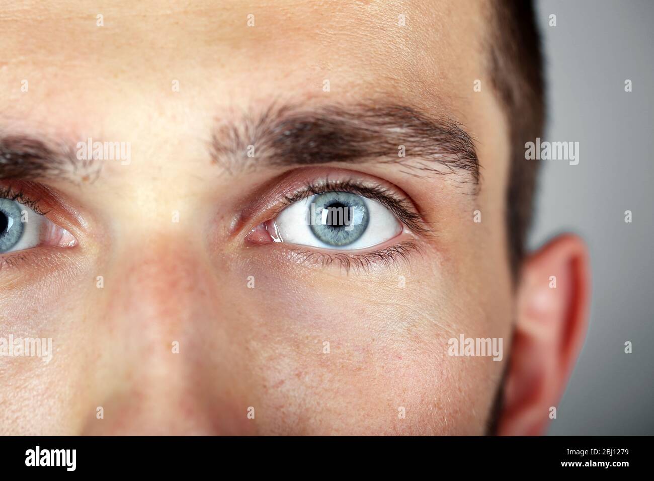 Beautiful blue man eyes close up Stock Photo - Alamy