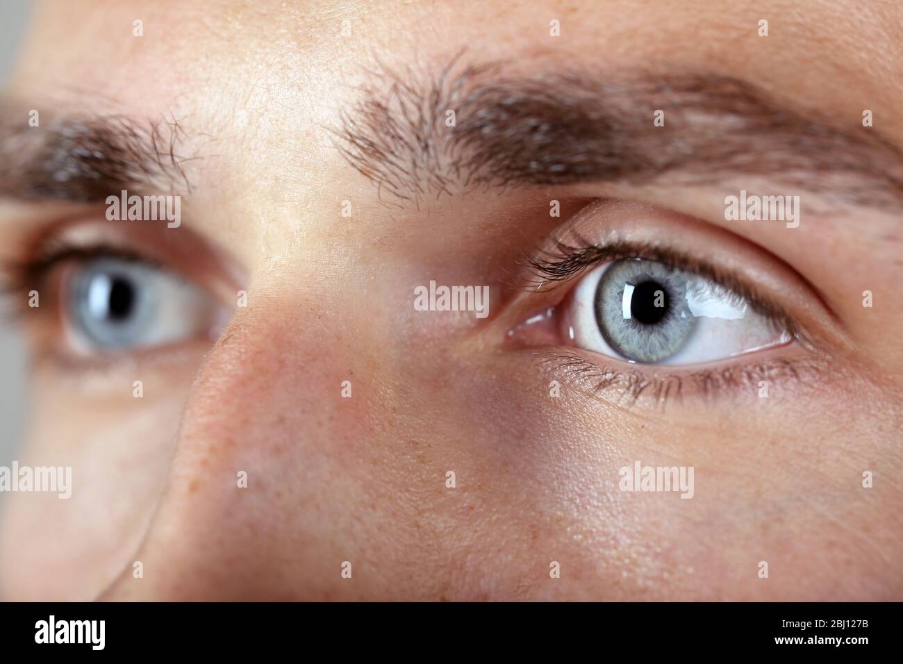 Beautiful blue man eyes close up Stock Photo - Alamy