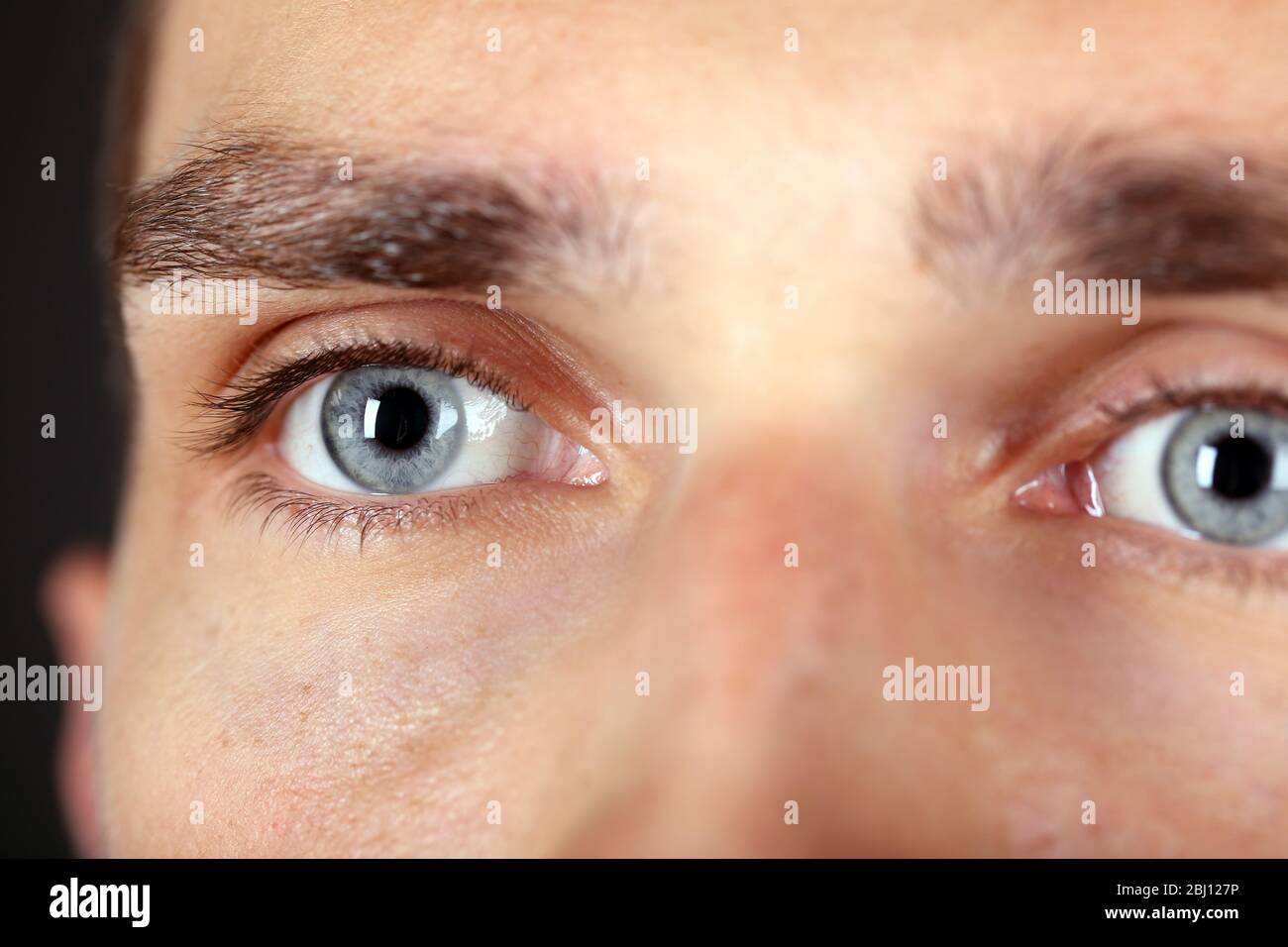 Beautiful blue man eyes close up Stock Photo - Alamy