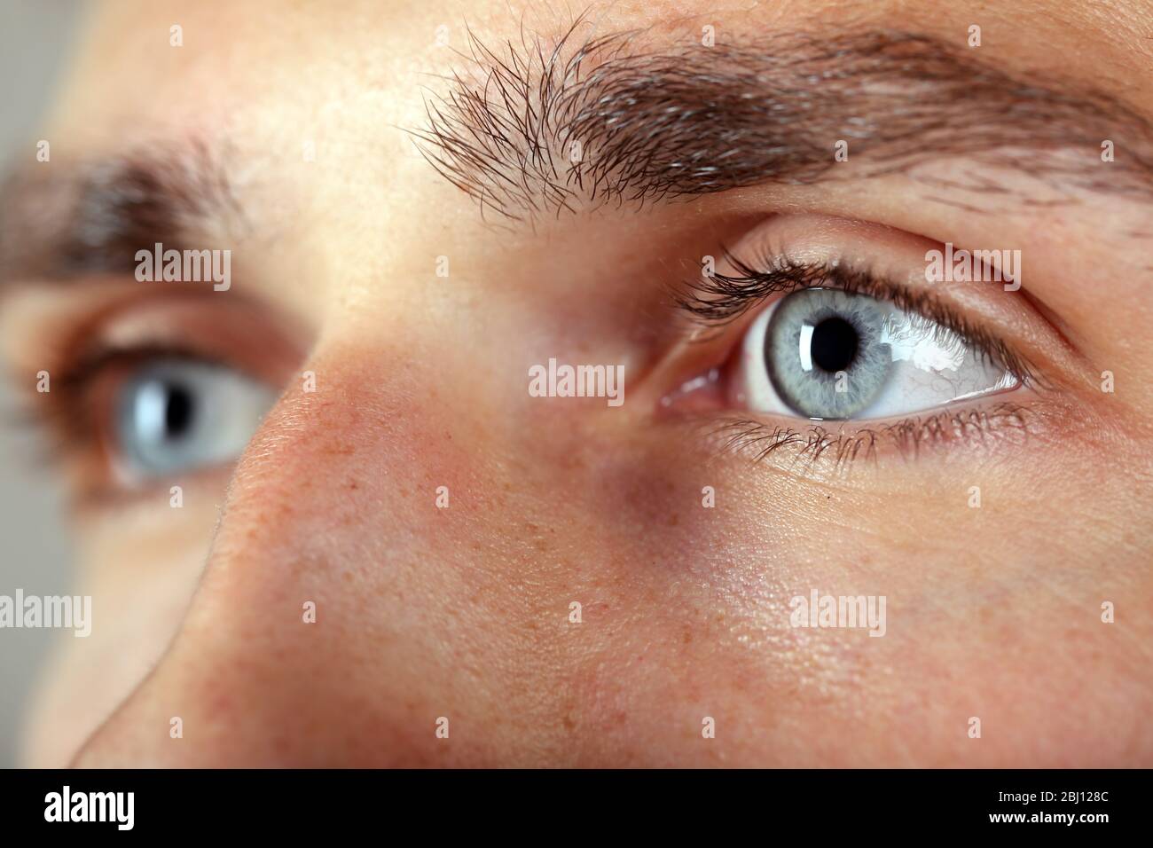 Beautiful blue man eyes close up Stock Photo - Alamy
