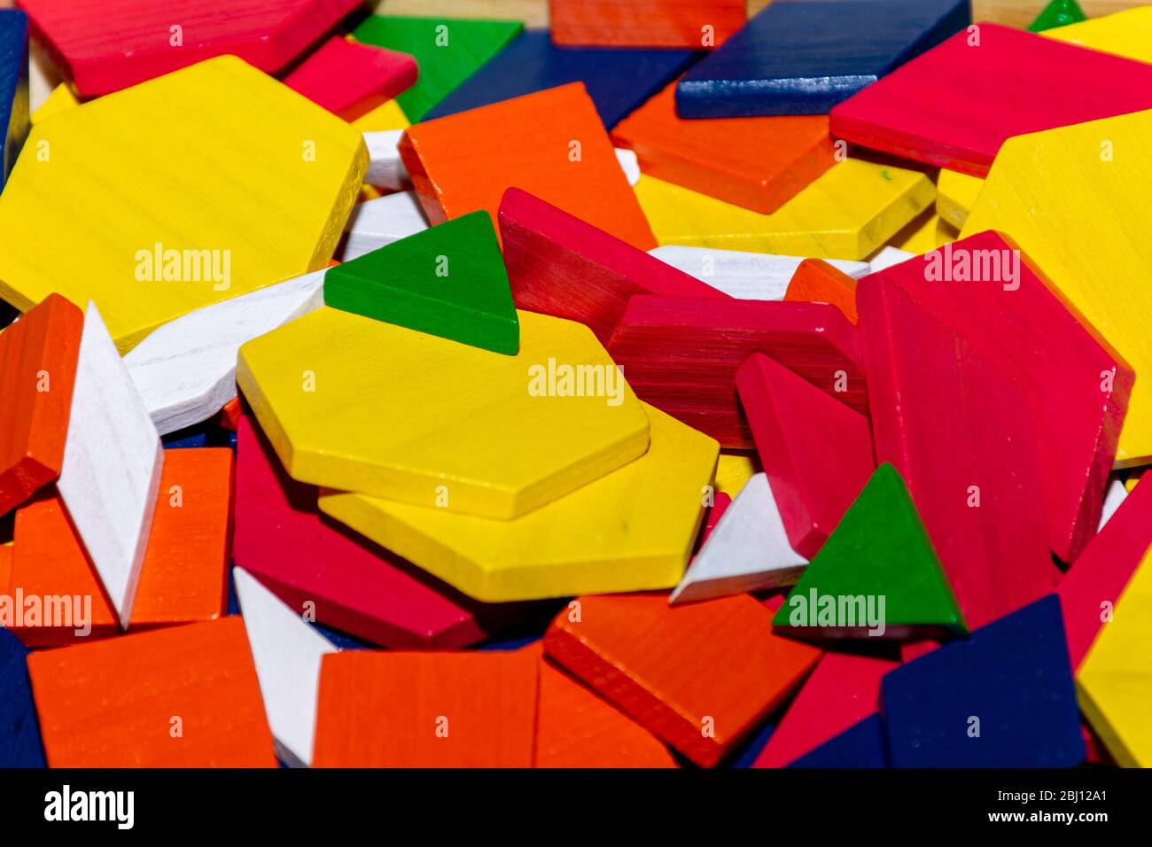Bright colored tangram child geometric shape puzzle pieces in a pile ...