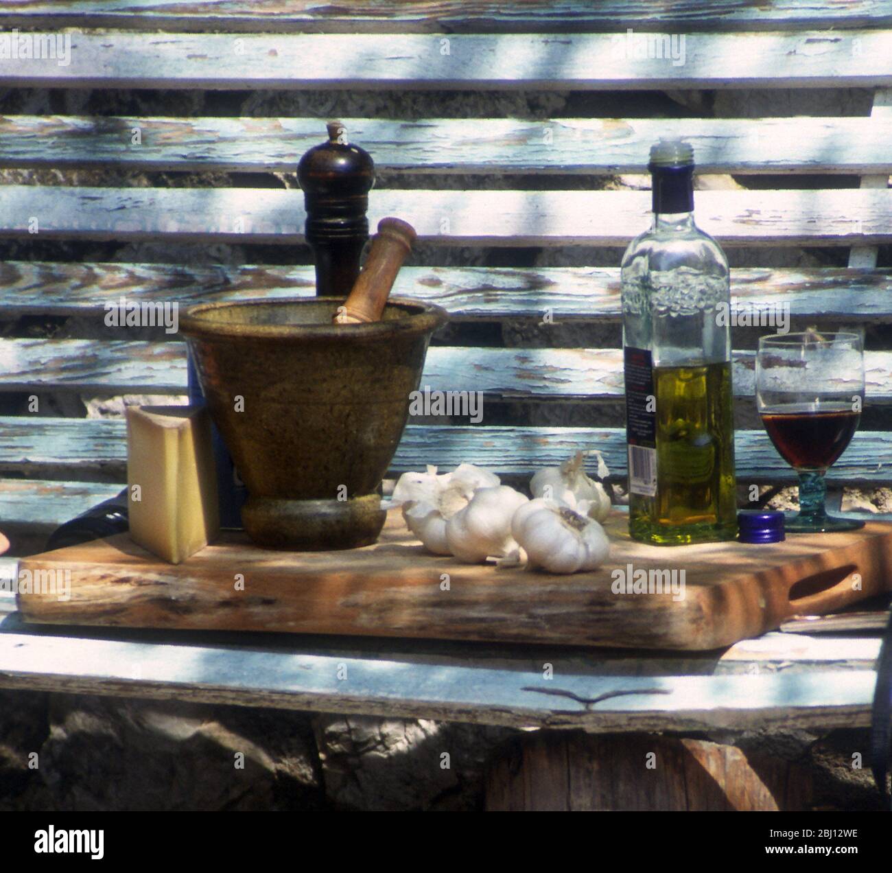 Ingredients outdoors - Olive oil, pestle and mortar, garlic - red wine ...