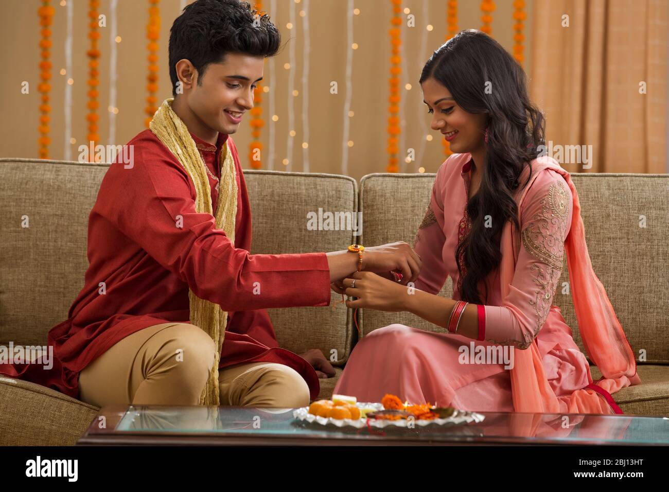 Young girl tying rakhi to her brother on RakshaBandhan Stock Photo - Alamy