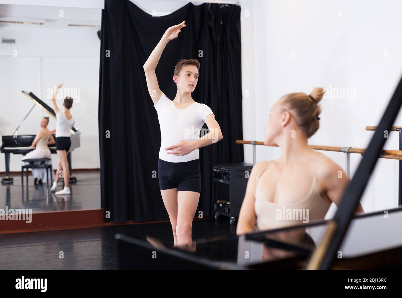 Female choreographer teaches young dancer in ballet studio Stock Photo ...
