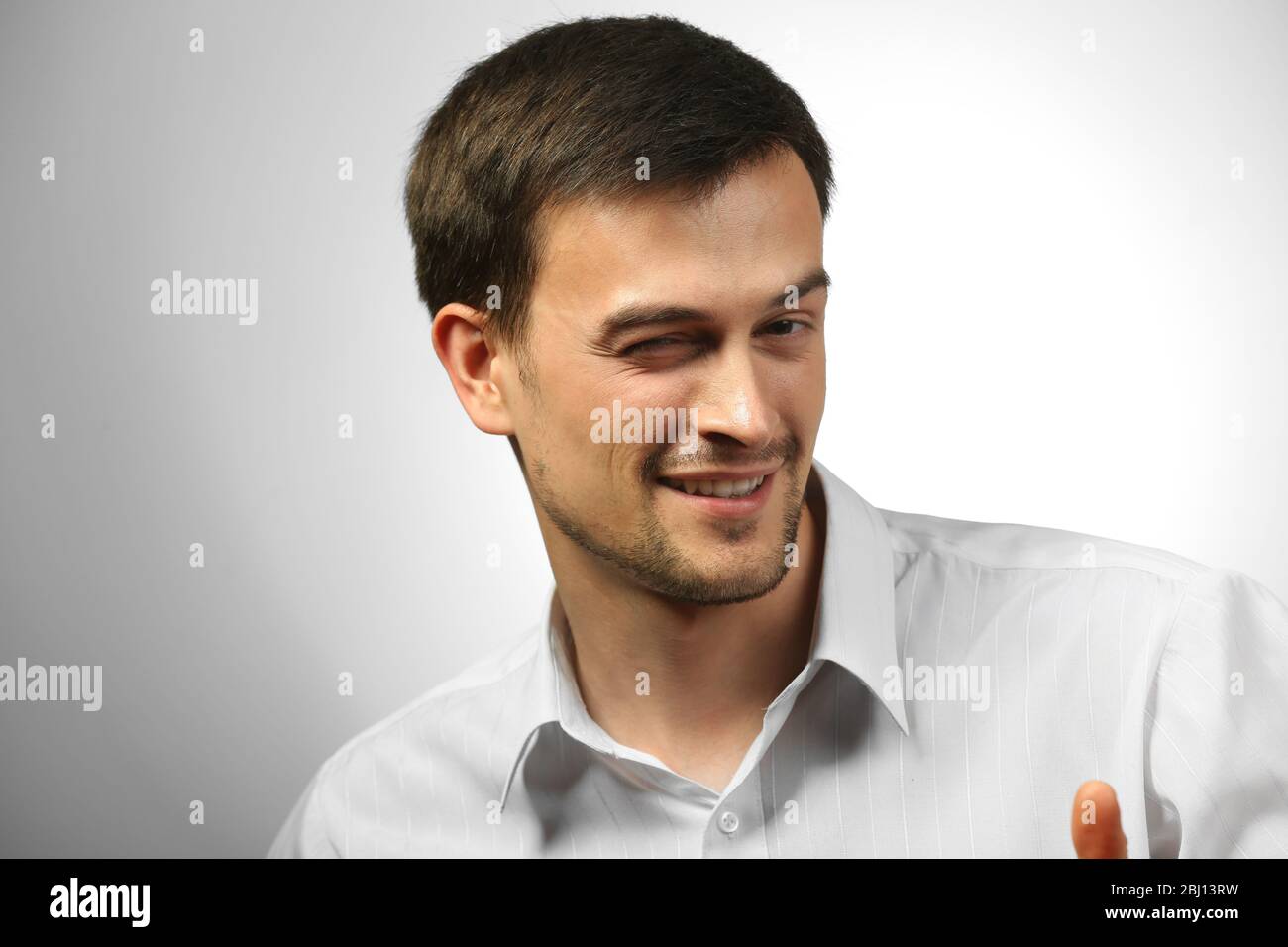 Handsome young man winks hi-res stock photography and images - Alamy