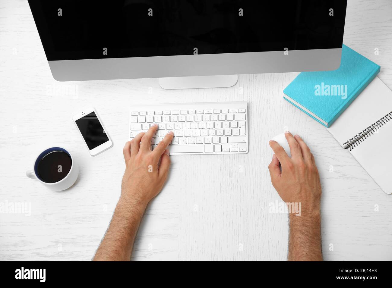 Man hand on computer keyboard on table top view Stock Photo - Alamy