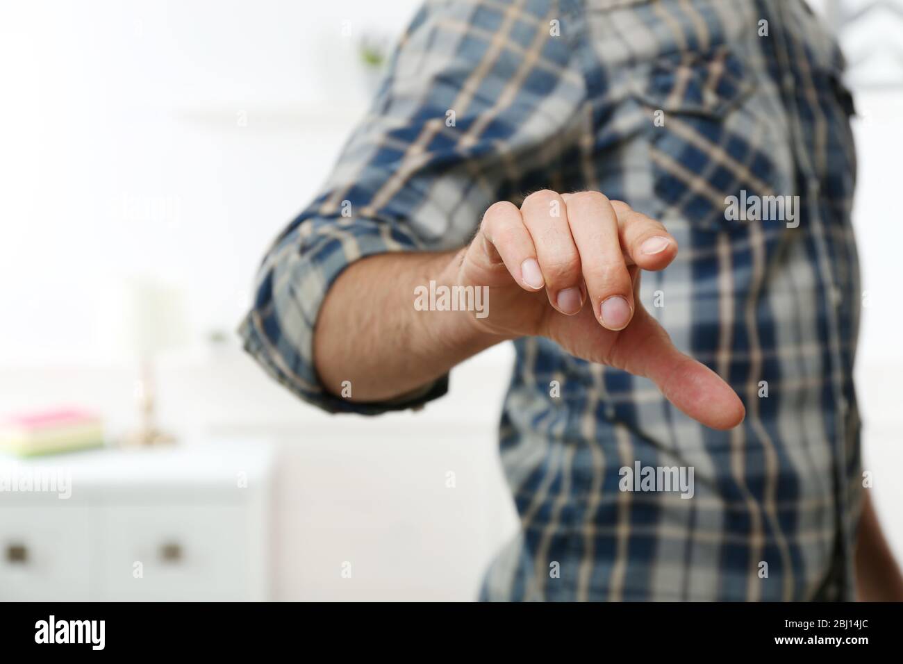 Young man push button Stock Photo - Alamy