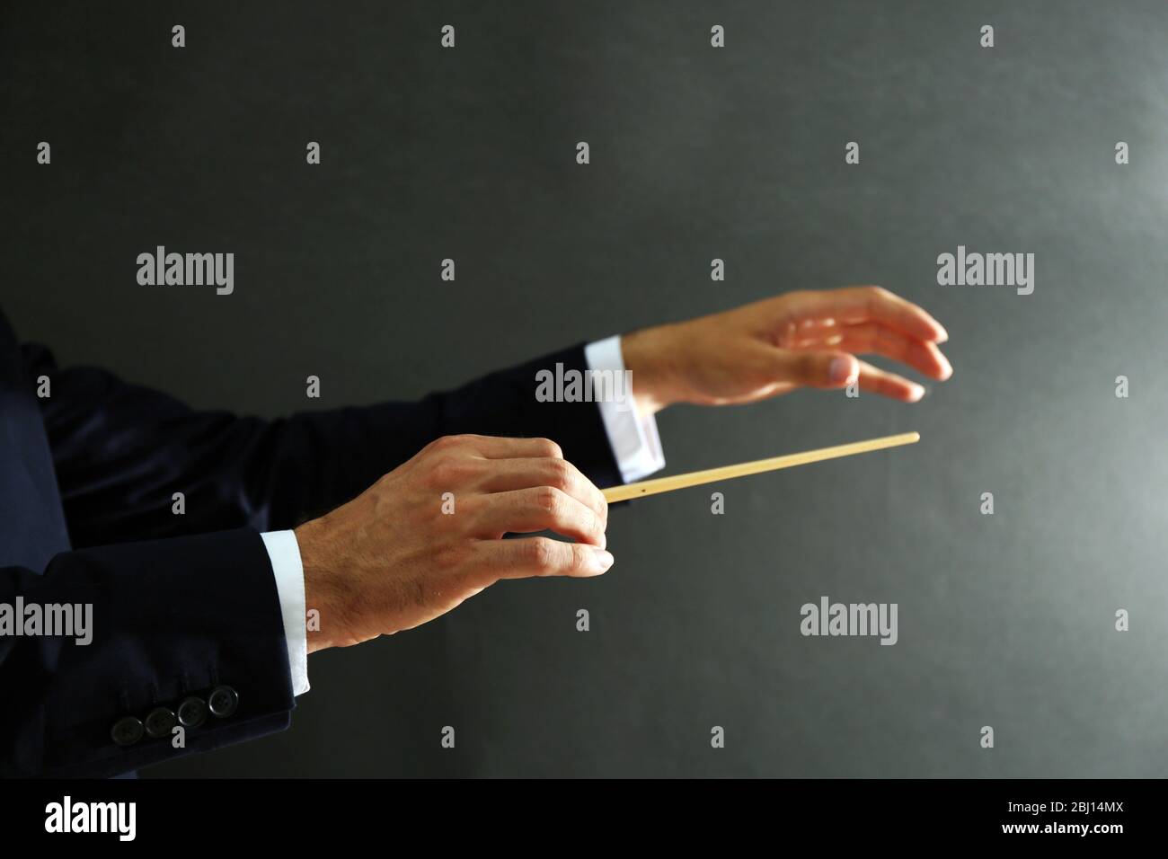 Music conductor hands with baton on black background Stock Photo - Alamy