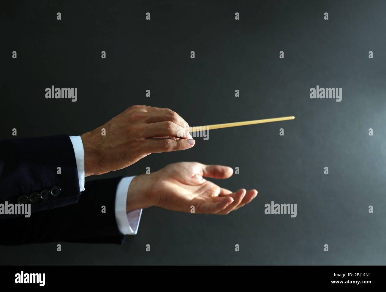 Music conductor hands with baton on black background Stock Photo - Alamy