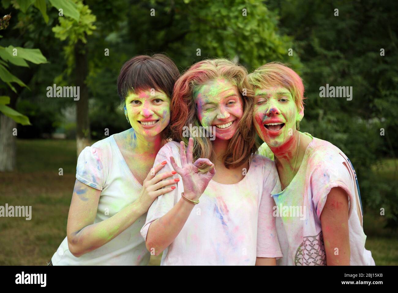 Young people celebrate Holi color festival in park Stock Photo - Alamy