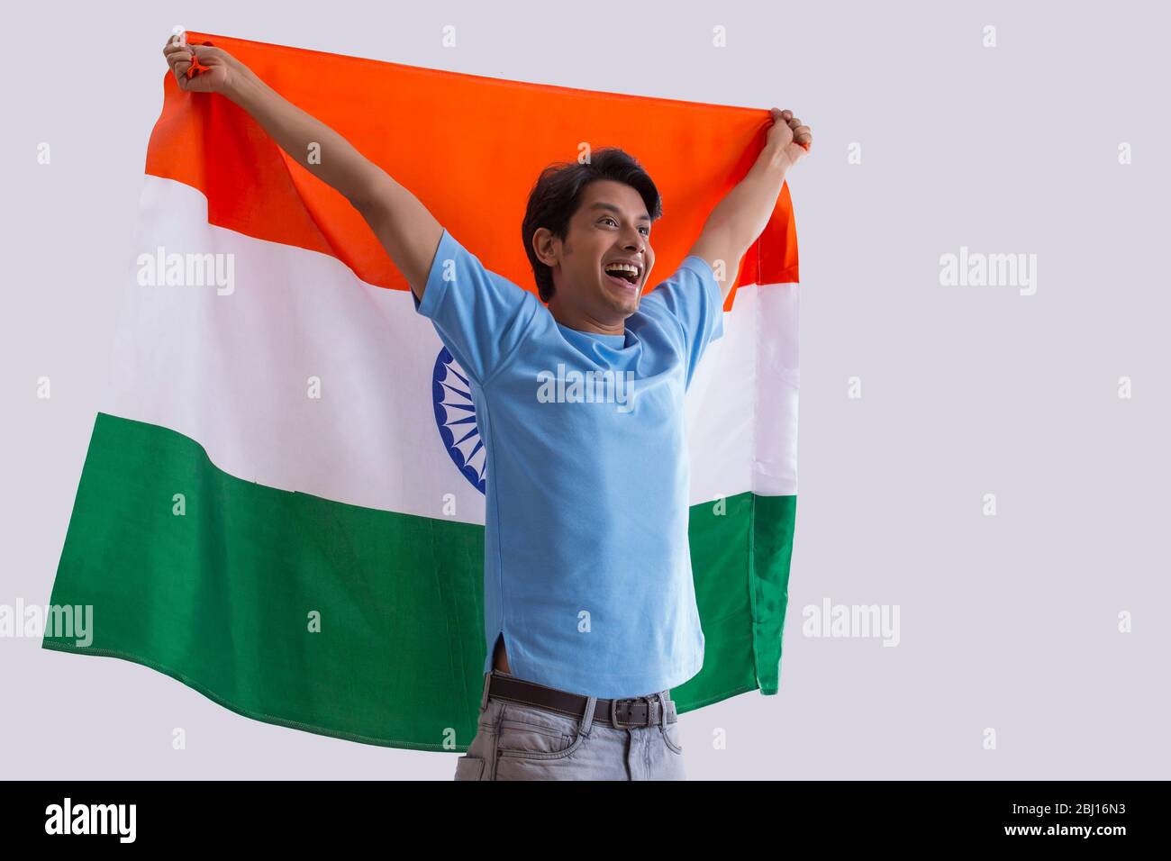 young man lifting indian flag in excitement, independence day Stock ...