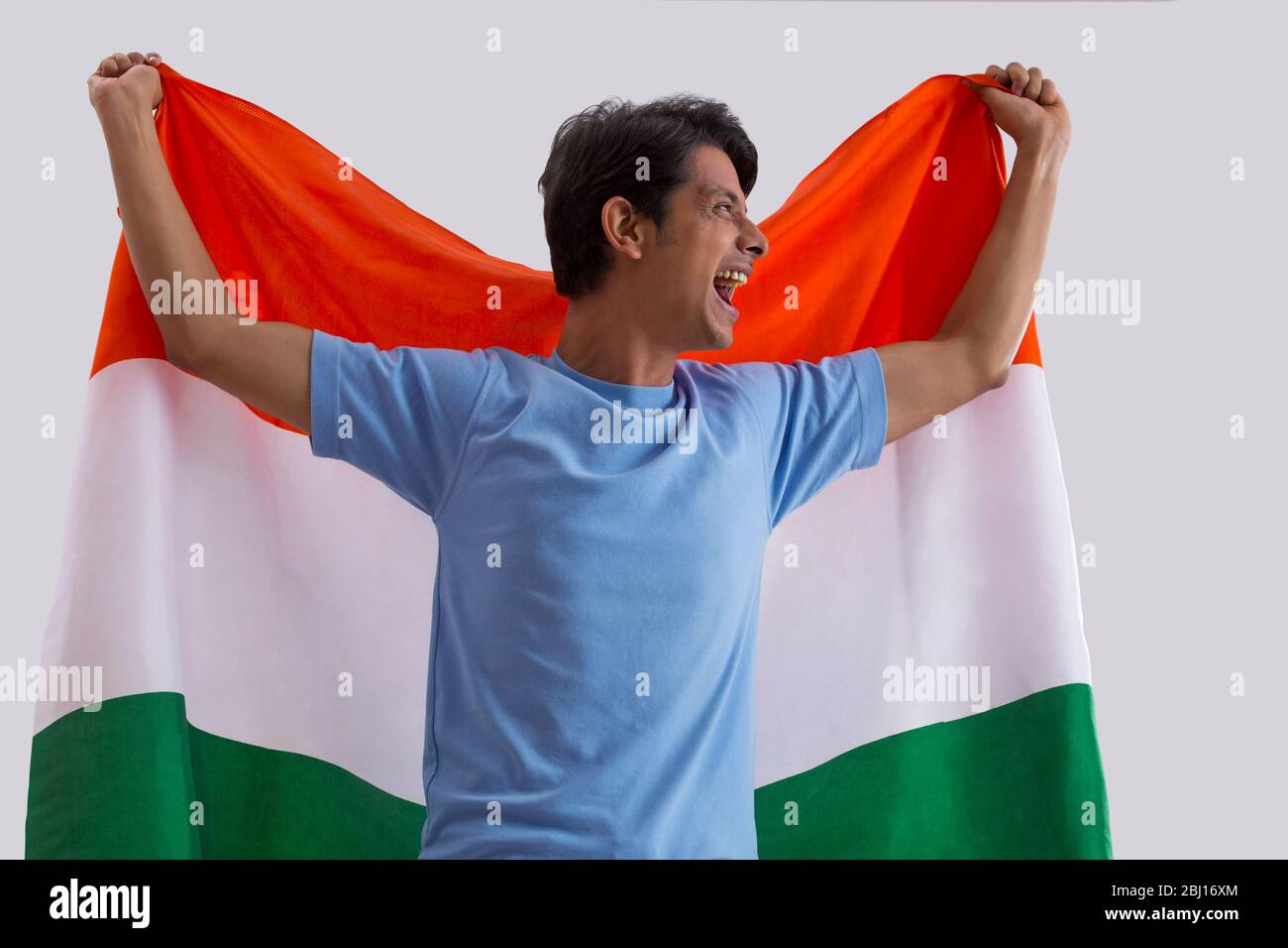 young man lifting indian flag in excitement, independence day Stock ...