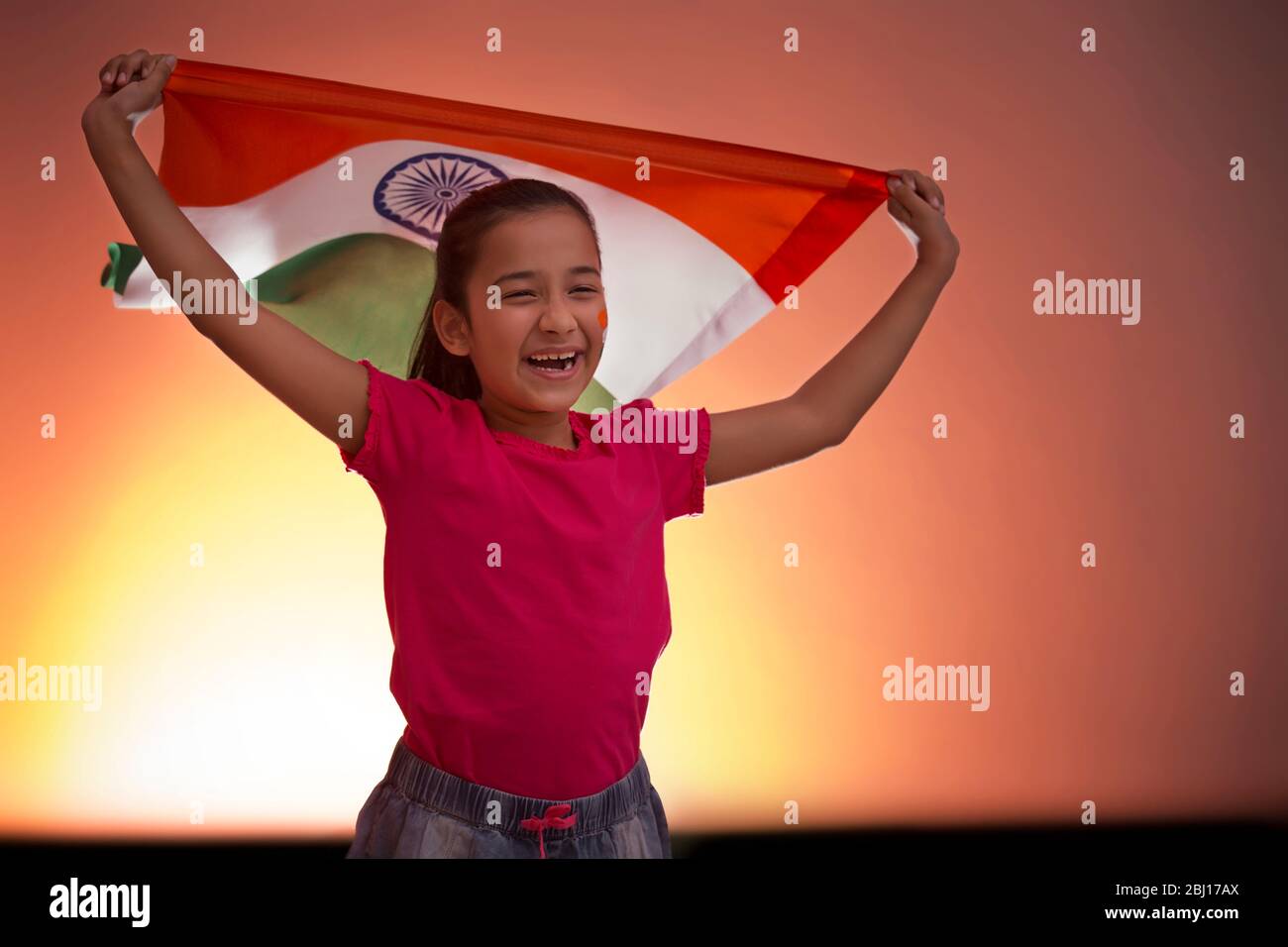 young girl lifting flag and smiling, independence day Stock Photo - Alamy