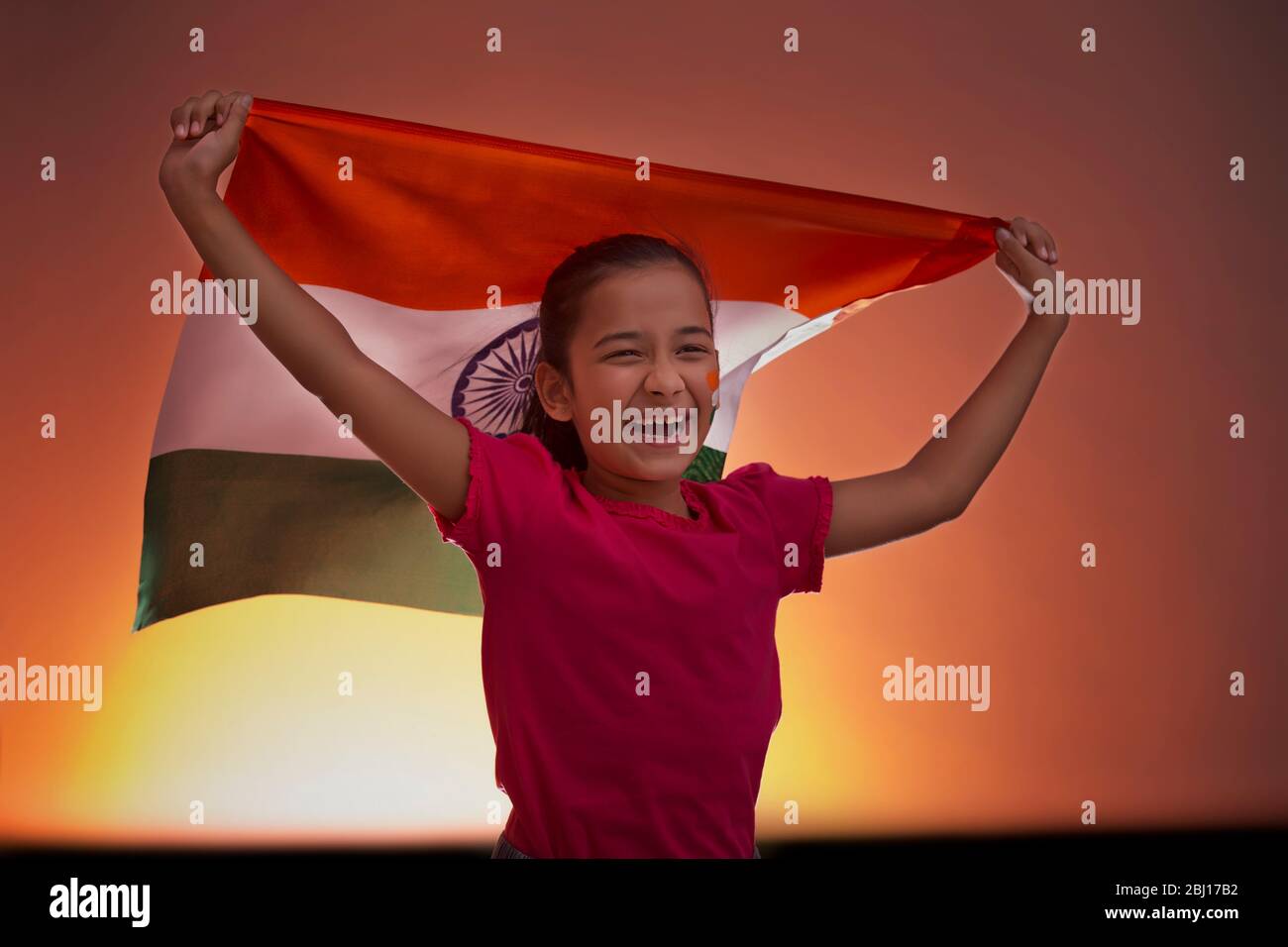 young girl lifting flag and smiling, independence day Stock Photo - Alamy