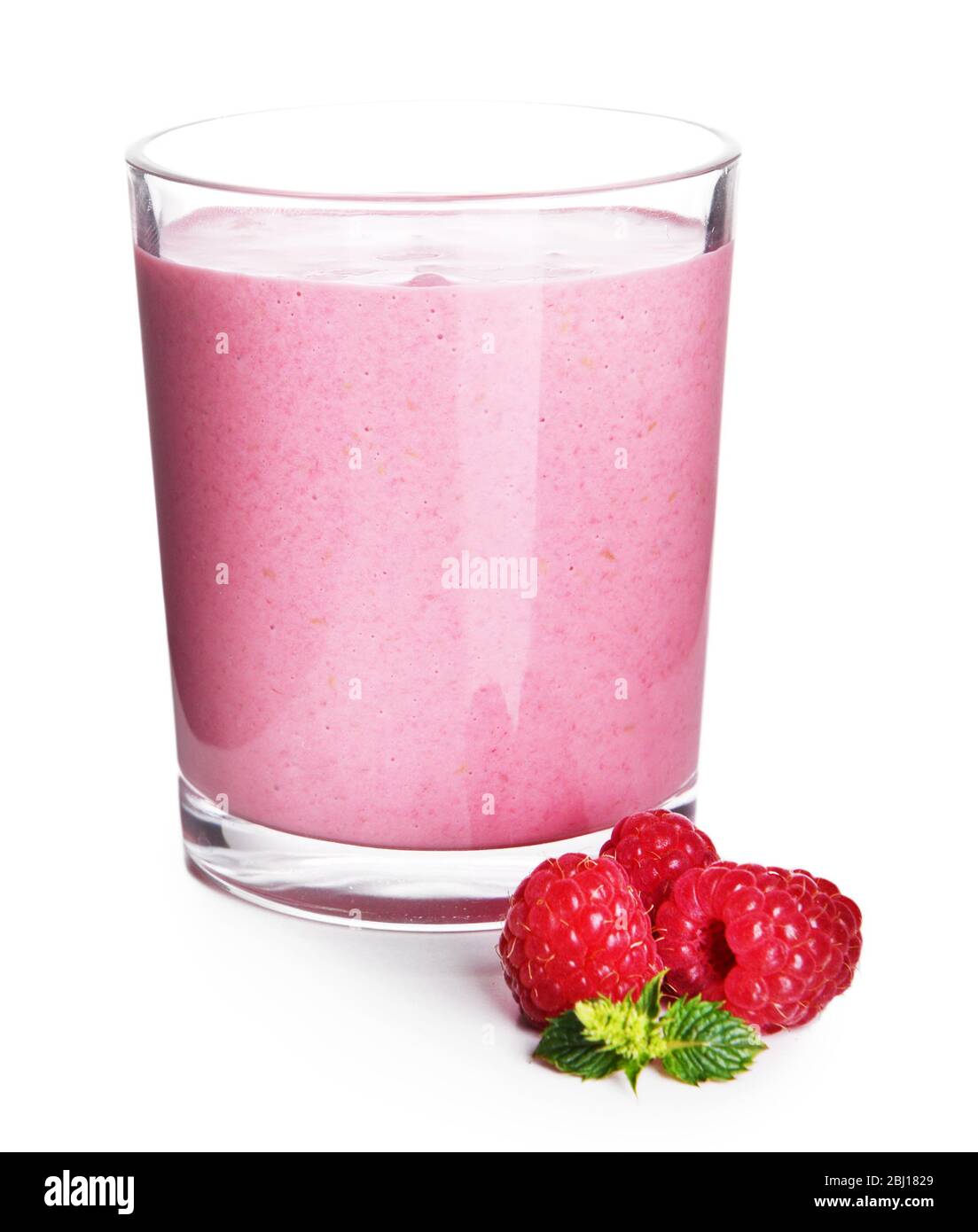 Glass of raspberry milk shake on light background Stock Photo - Alamy