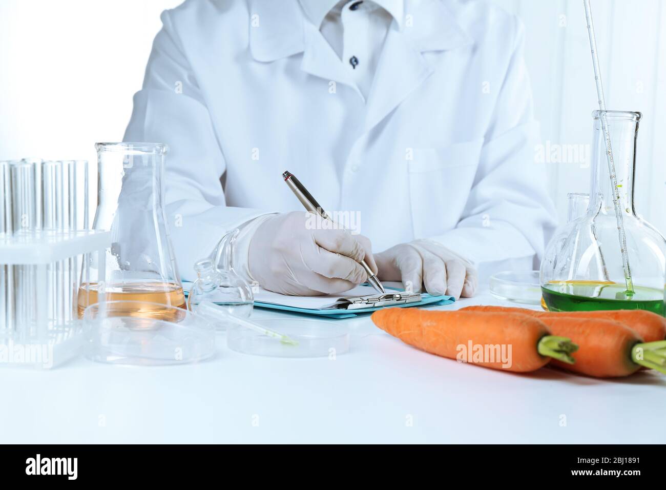 Scientist examines carrots in laboratory Stock Photo - Alamy