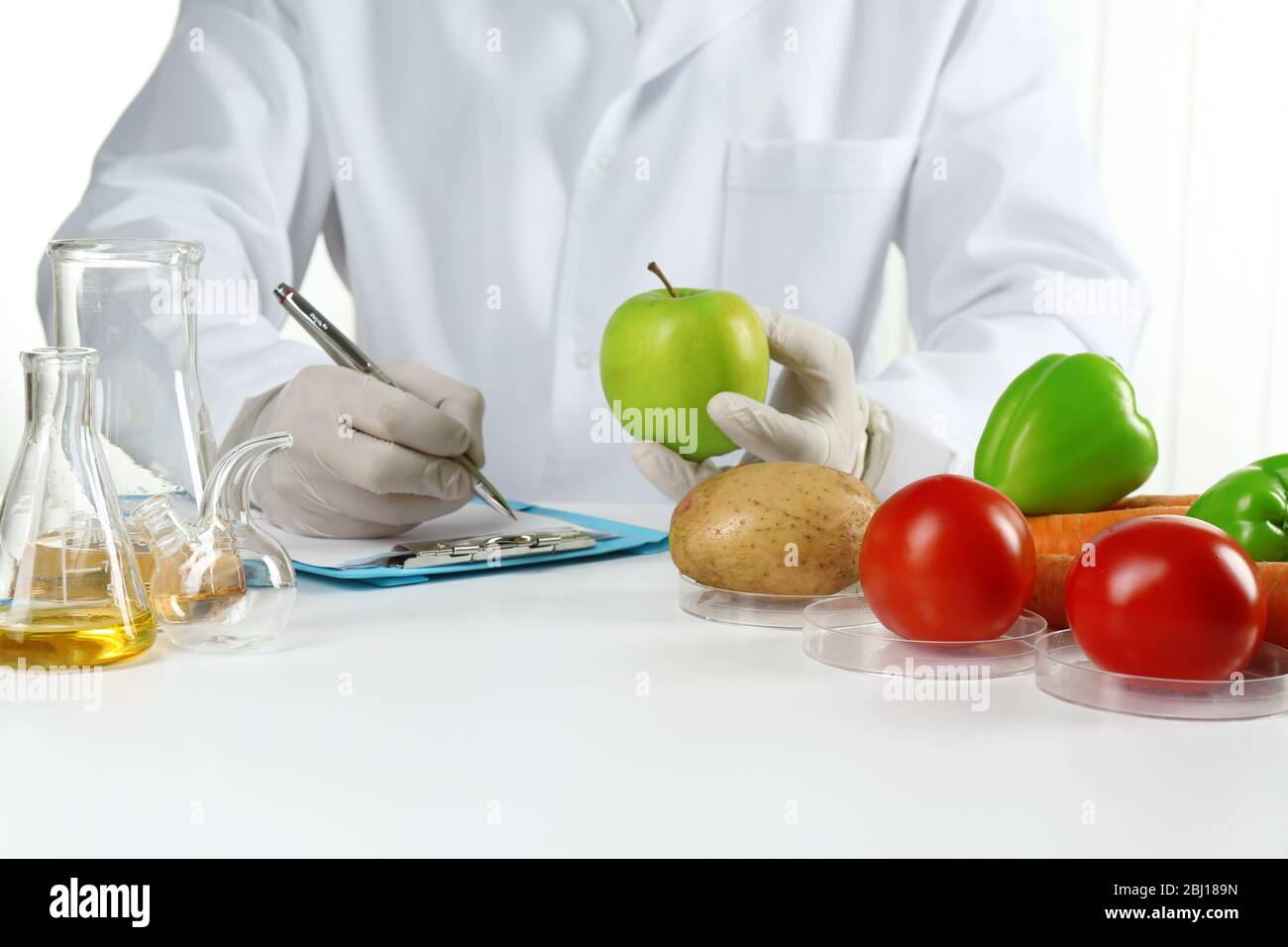 Scientist examines vegetables in laboratory Stock Photo - Alamy