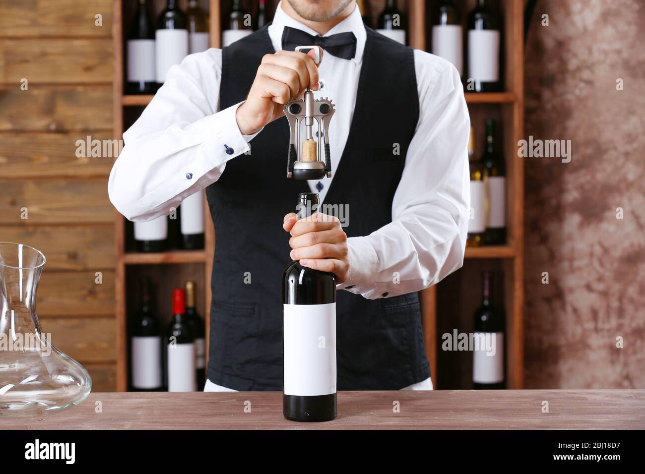 Bartender working at counter on bar background Stock Photo - Alamy