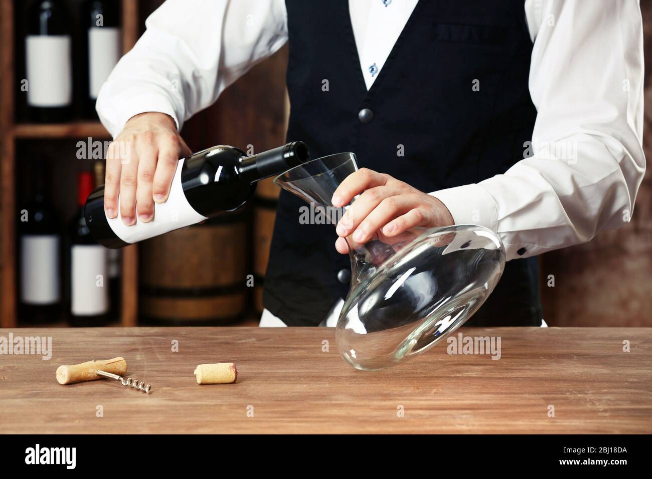 Bartender working at counter on bar background Stock Photo - Alamy