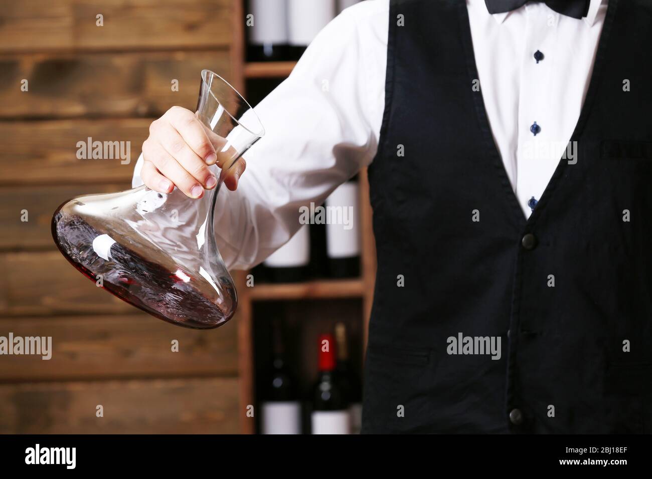Bartender working on bar background Stock Photo - Alamy