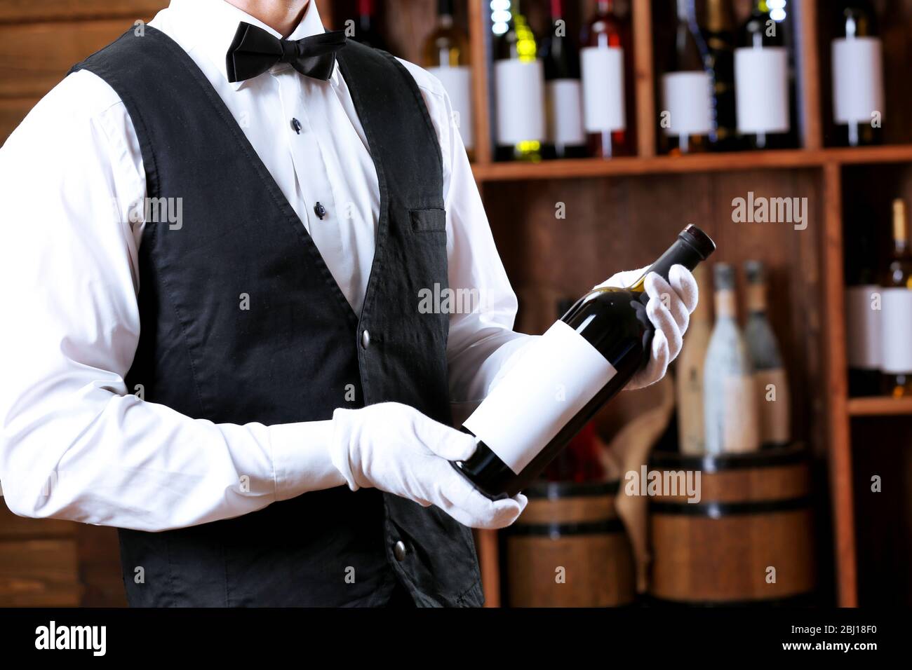 Bartender working on bar background Stock Photo - Alamy