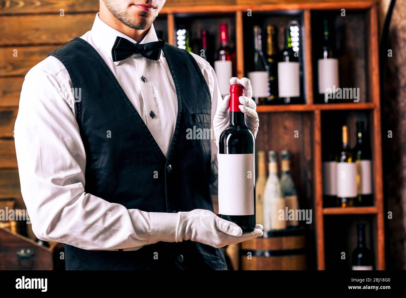Bartender working on bar background Stock Photo - Alamy