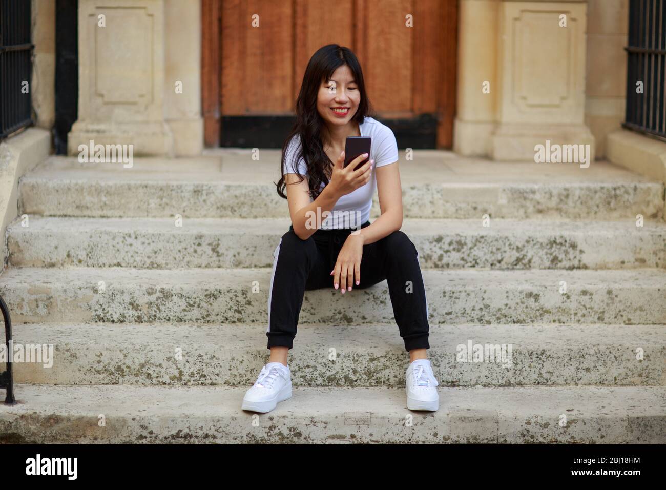 a happy chinese lady reading a text message Stock Photo - Alamy