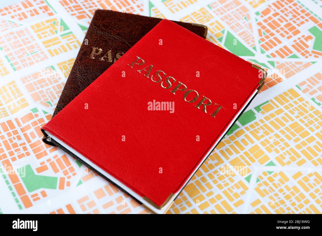 Passports on map background Stock Photo - Alamy