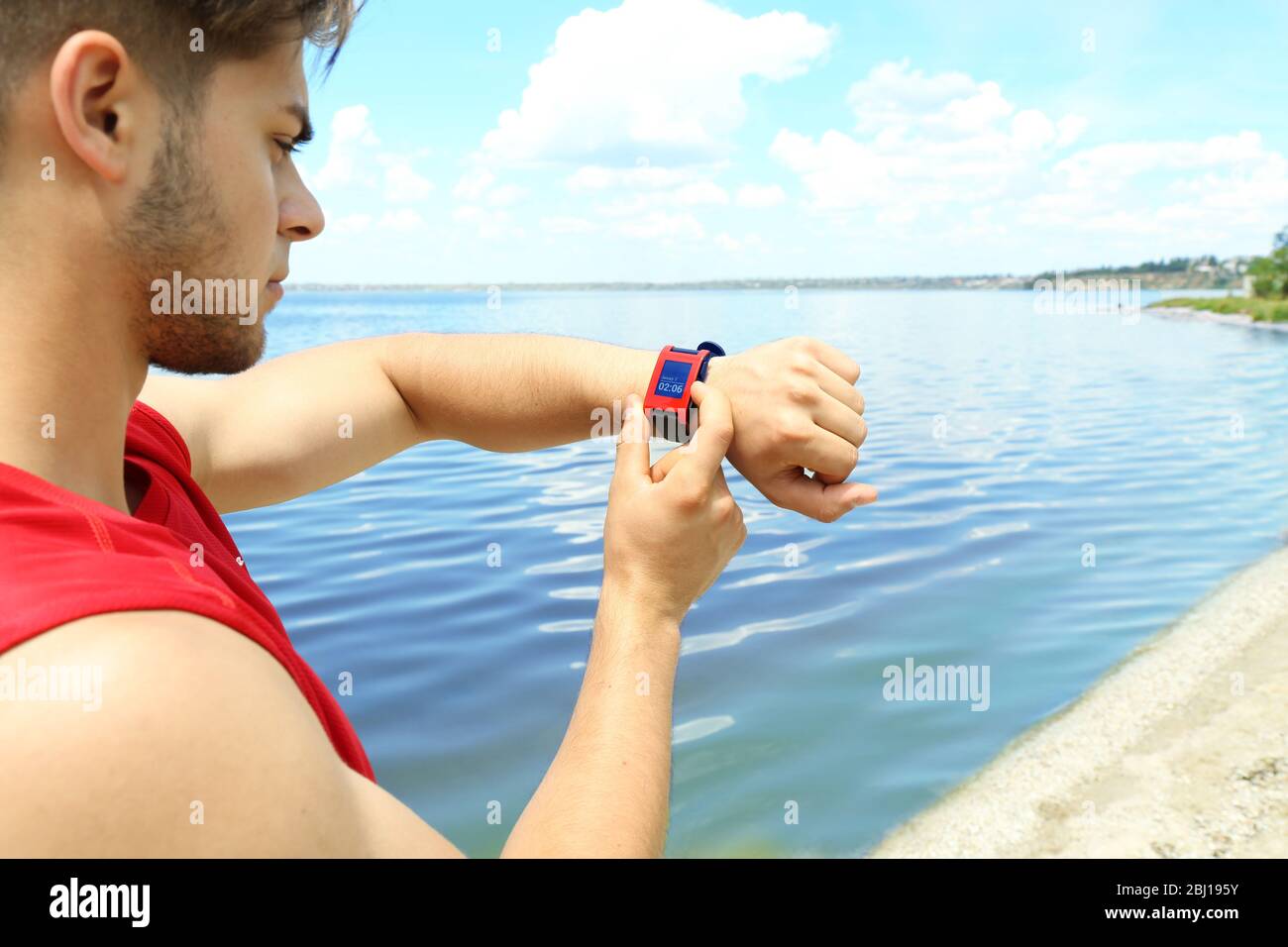 Runner looking at sports smart watch outdoors Stock Photo - Alamy
