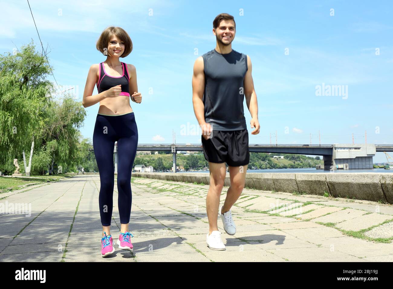 Young people jogging outdoors Stock Photo - Alamy