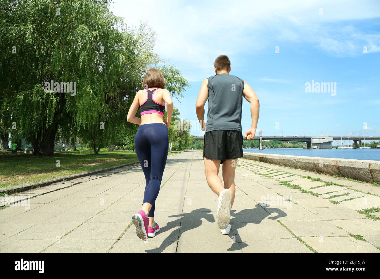 Young people jogging outdoors Stock Photo - Alamy