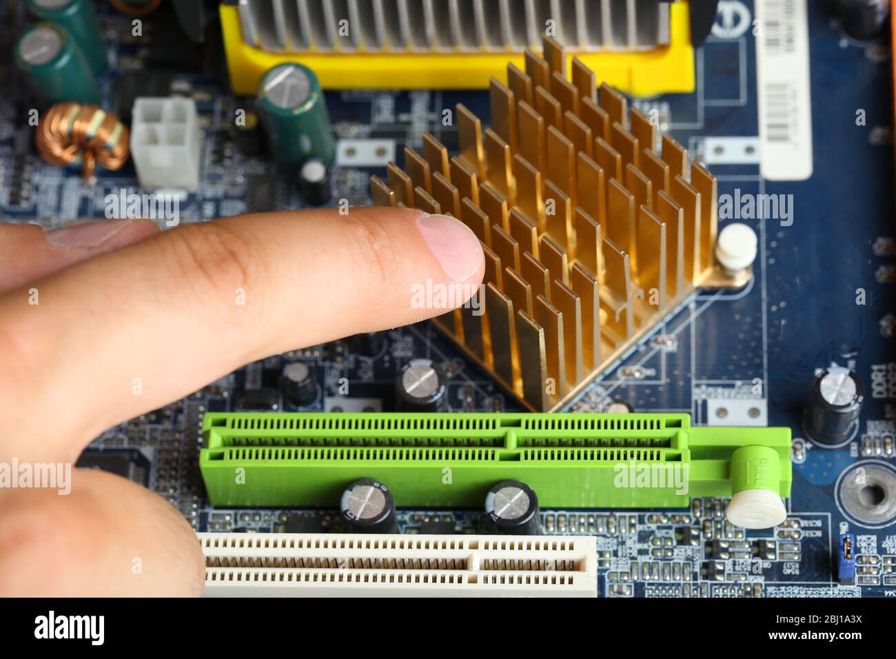 Finger points to motherboard, closeup Stock Photo - Alamy