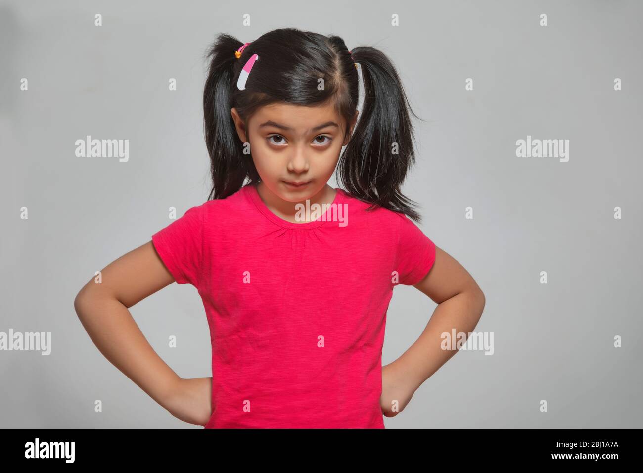 portrait of a young girl looking at the camera raising eyebrows Stock ...