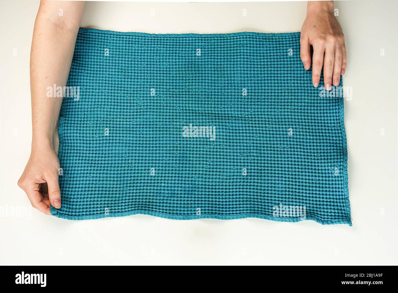 Step 1, spread the towel evenly on a flat surface Stock Photo - Alamy
