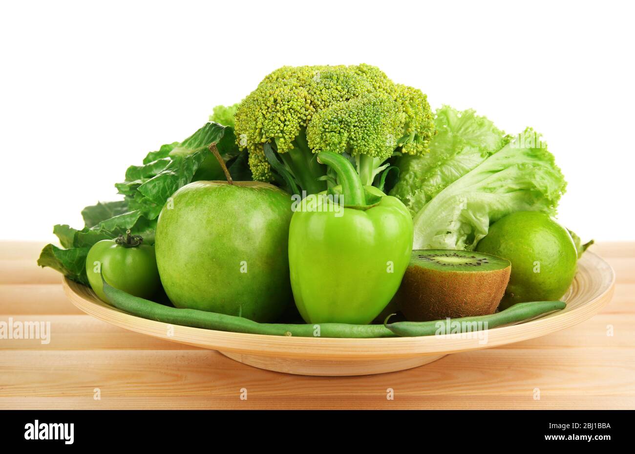 Fresh green food in wooden plate isolated on white Stock Photo - Alamy