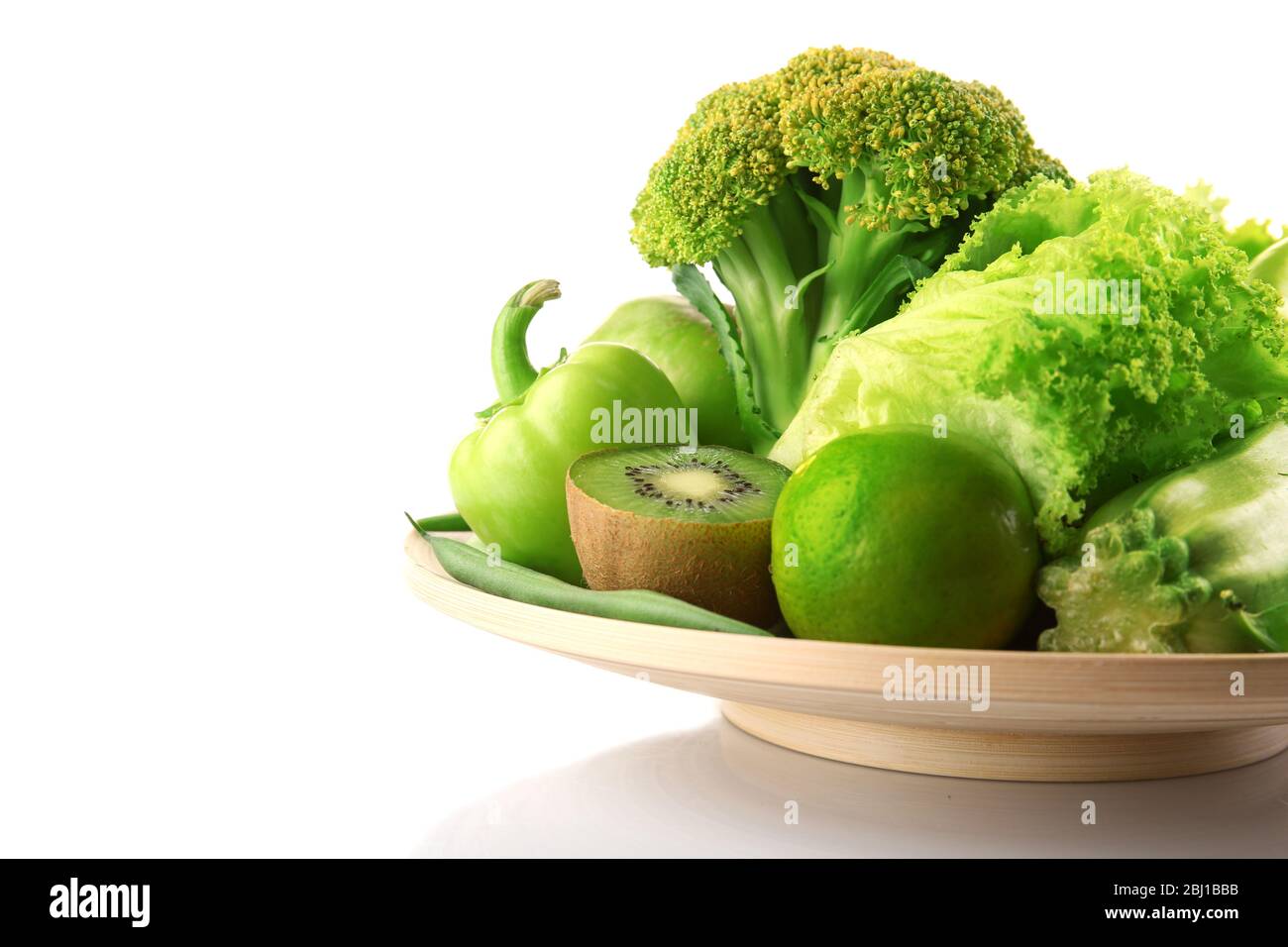 Fresh green food in wooden plate isolated on white Stock Photo - Alamy