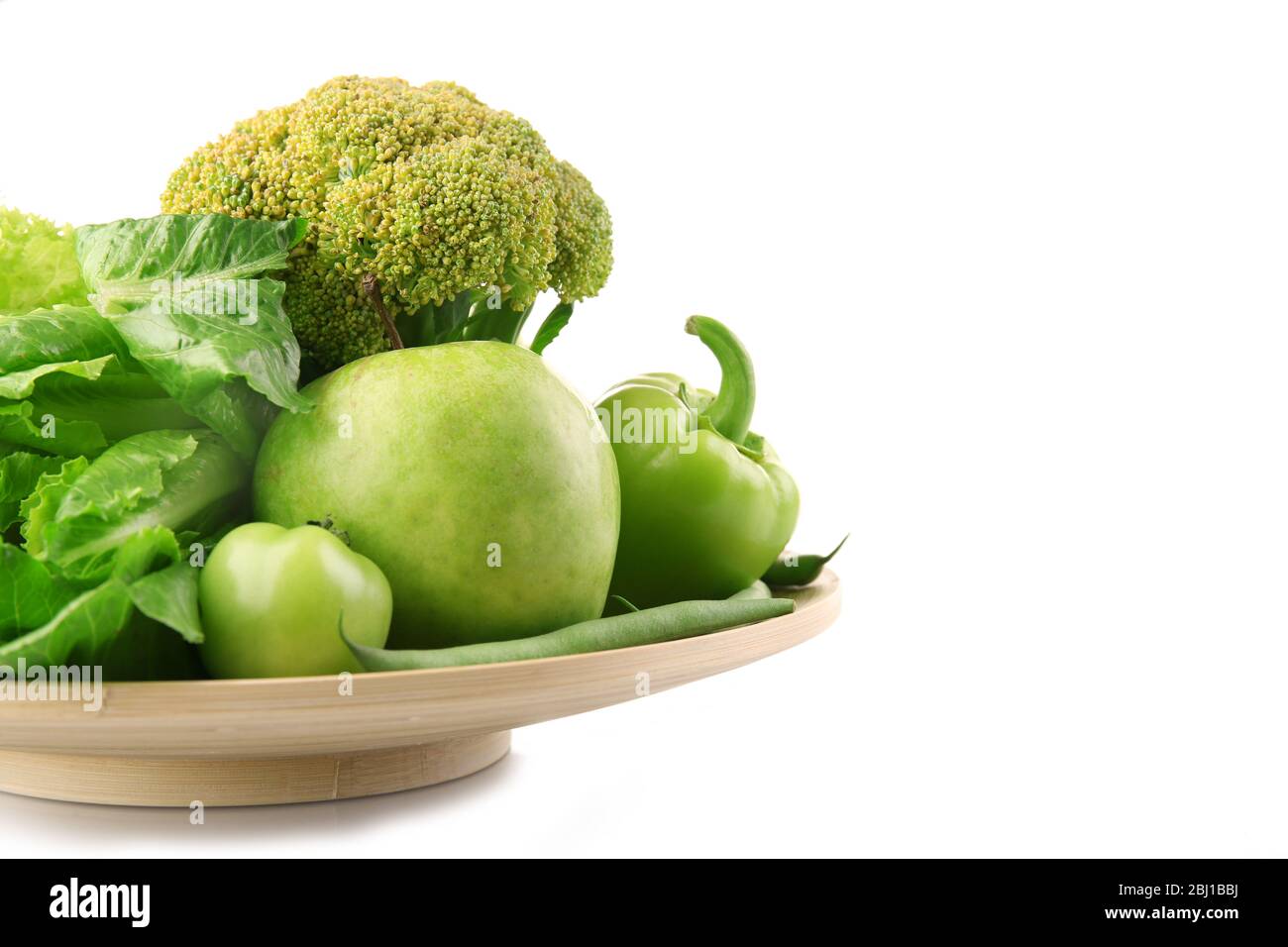 Fresh green food in wooden plate isolated on white Stock Photo - Alamy