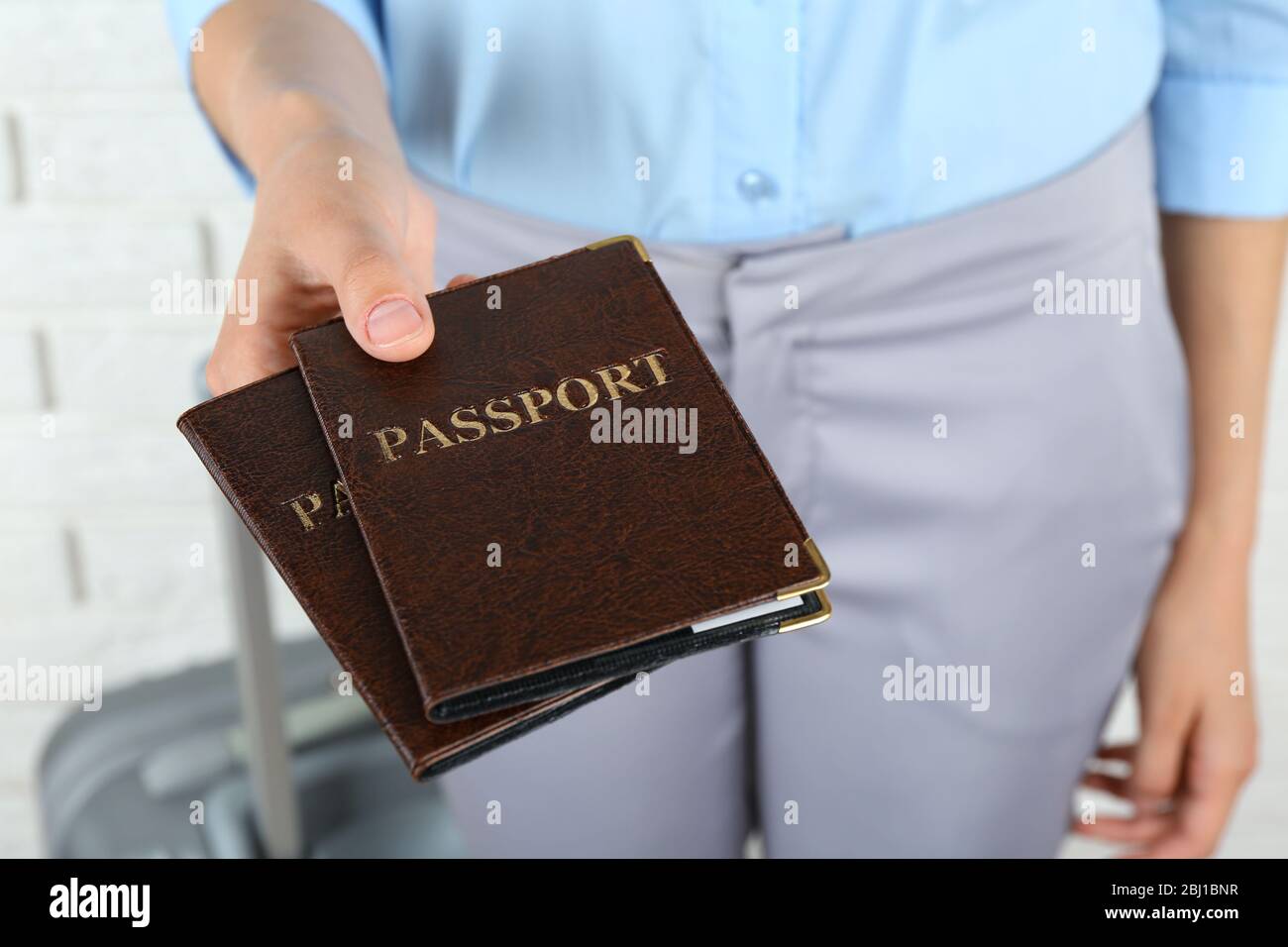 Female hand holding passports, closeup Stock Photo - Alamy