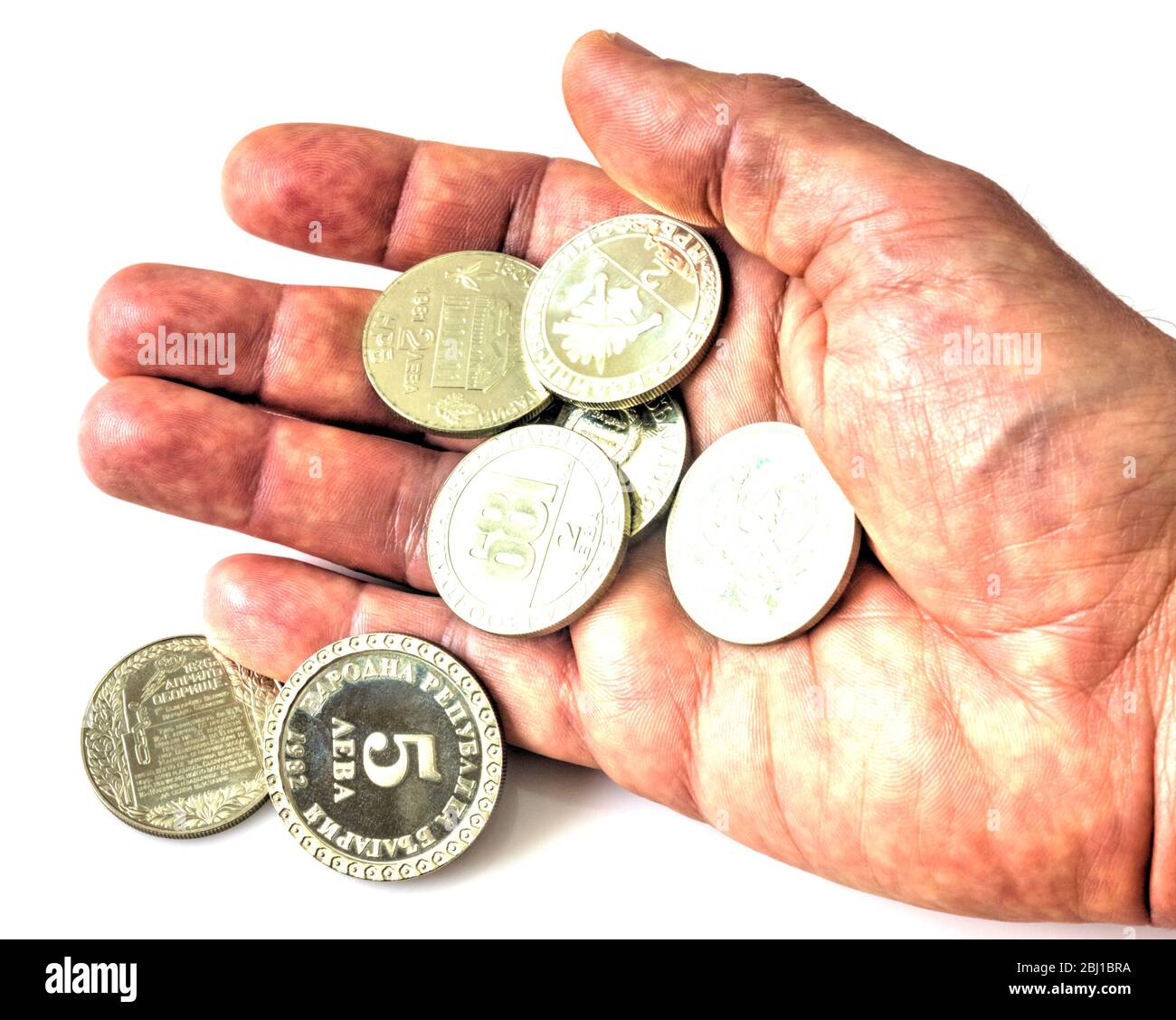 A pile of anniversary coins of republic of Bulgaria in a human's hand ...