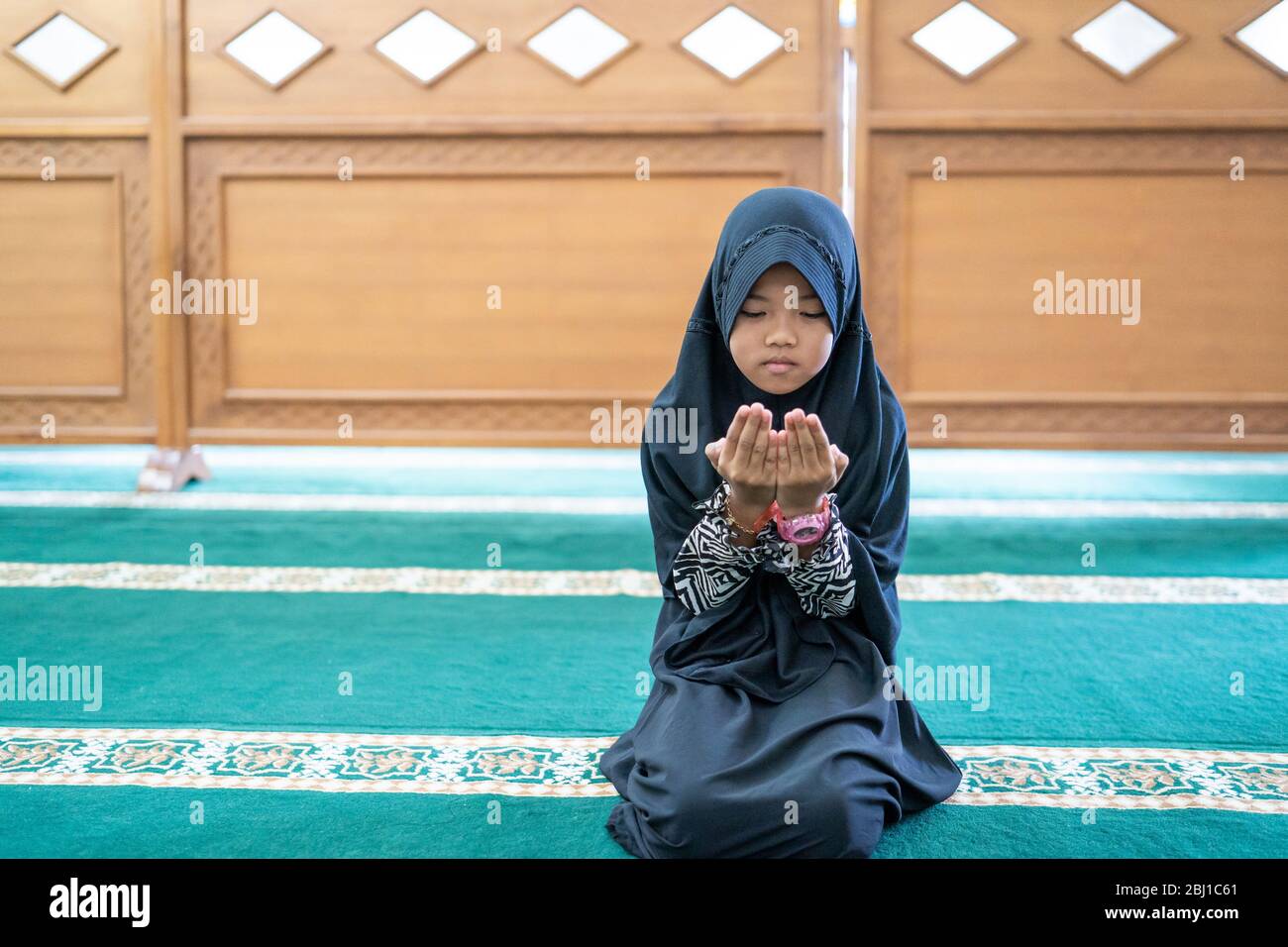 kid muslim praying to god by open arm in the mosque Stock Photo - Alamy